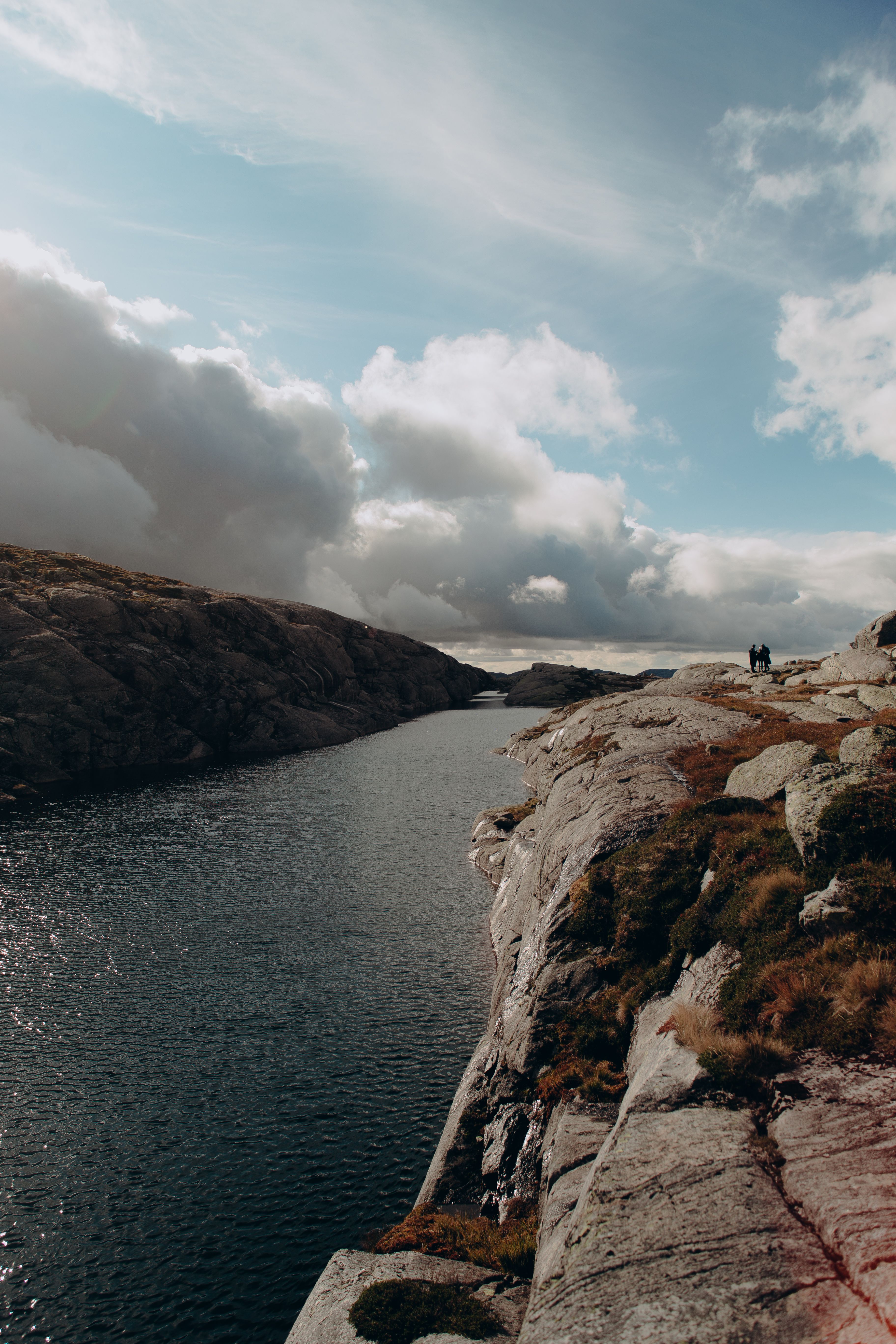 People Walking Along a Trail Next to a River · Free Stock Photo