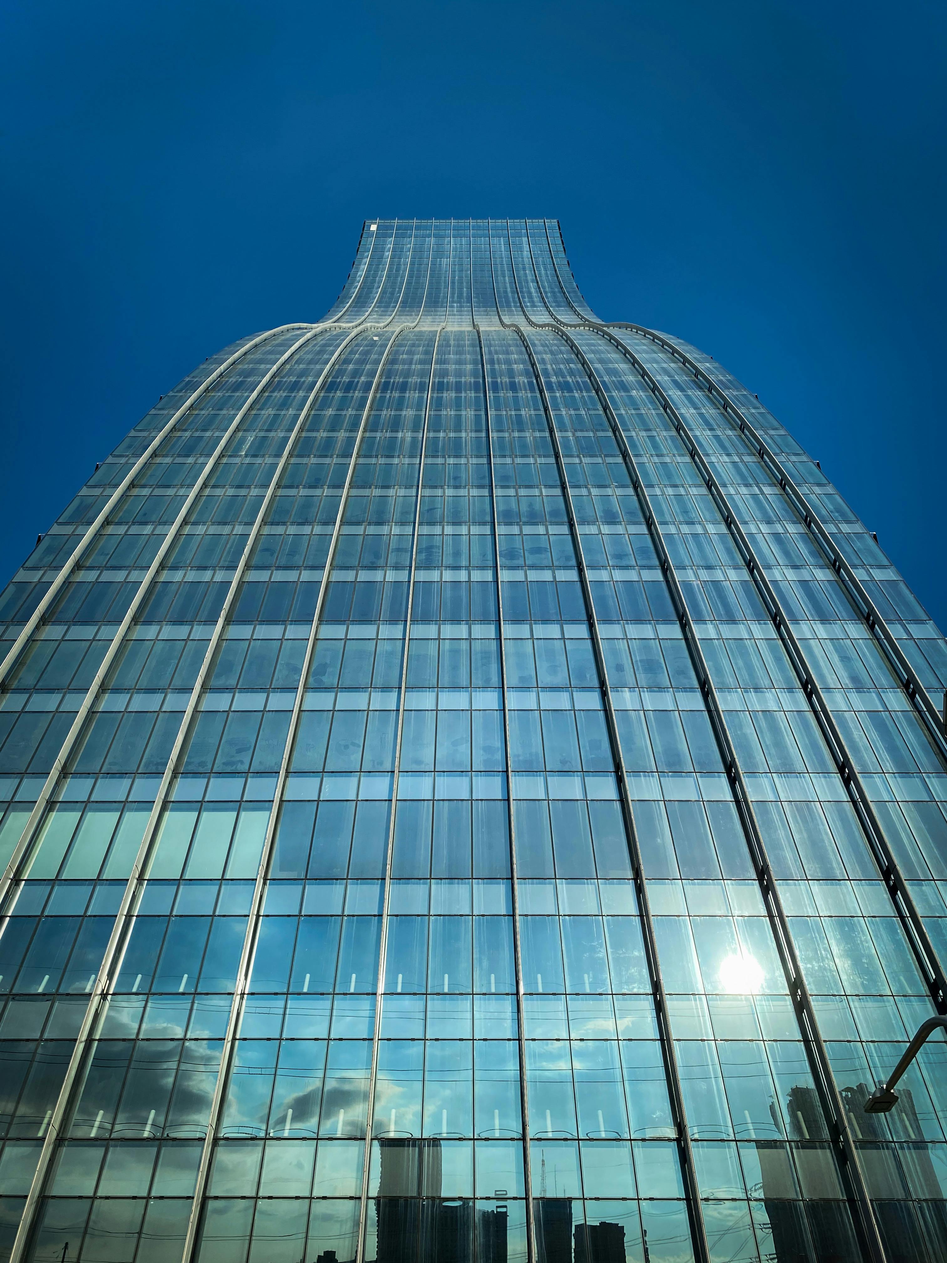 Man Standing With Background of Glass High Rise Building · Free Stock Photo