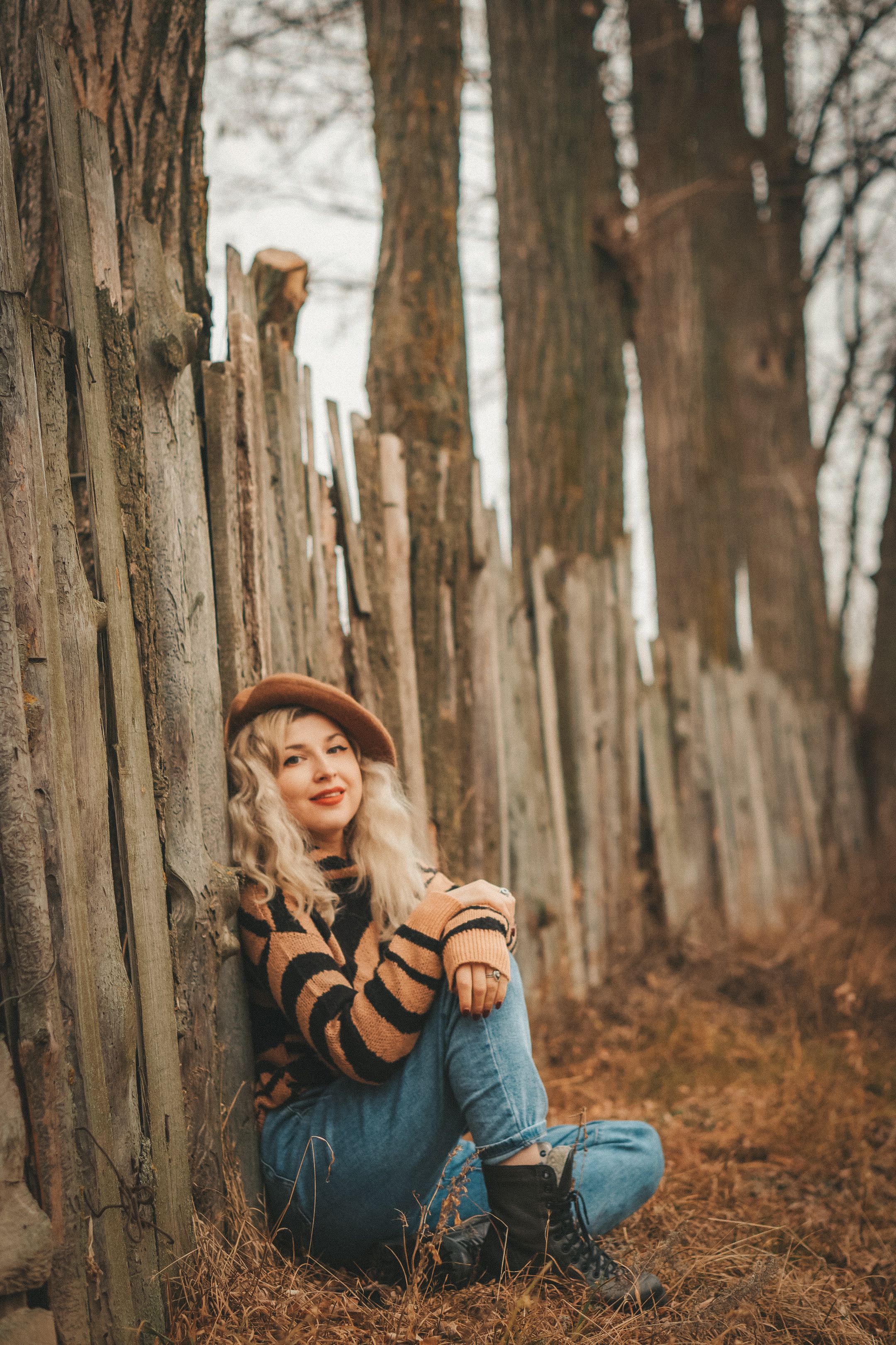 Photo of a Smiling Woman Wearing Fedora Hat and Stilettos Leaning on ...