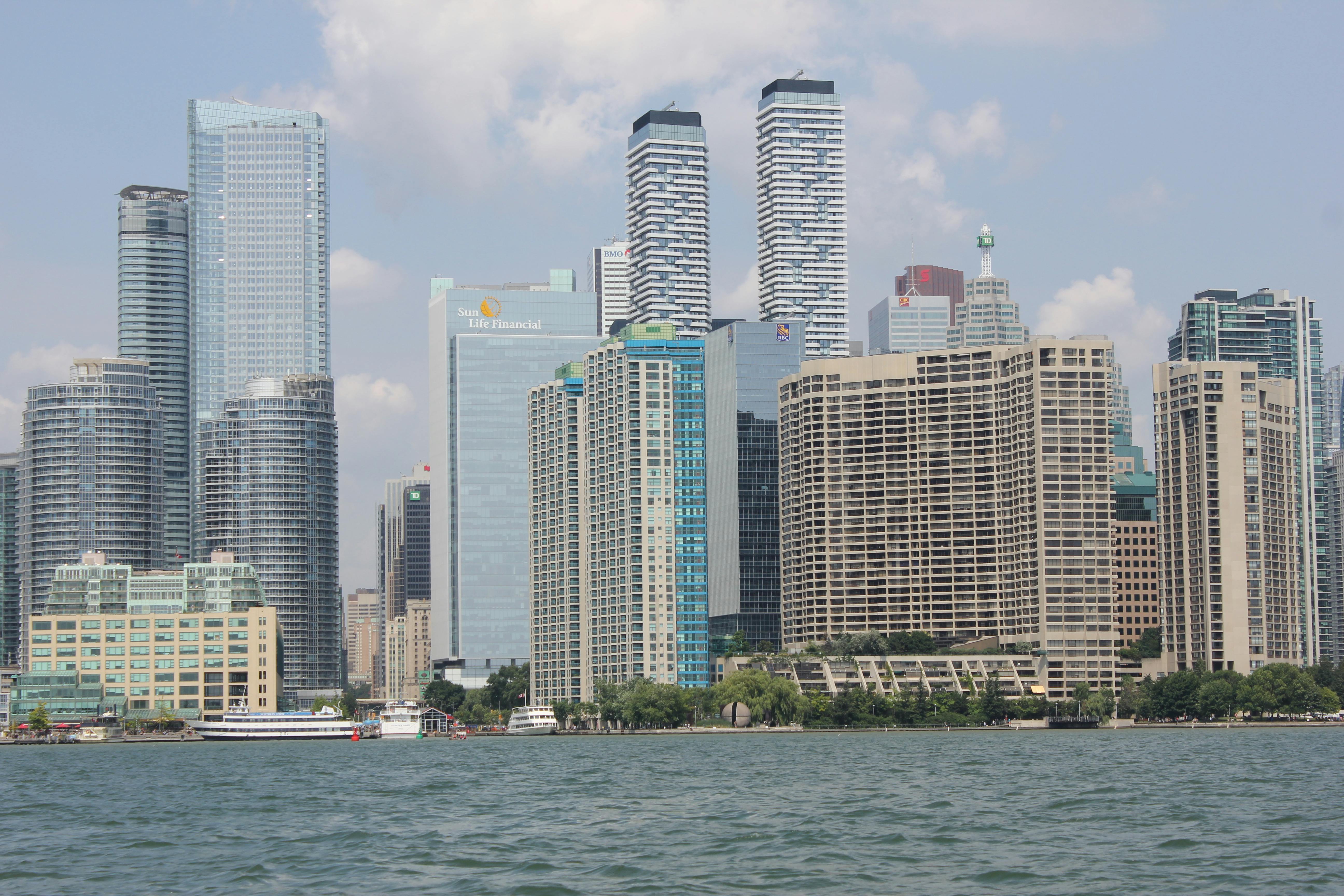 City Buildings Beside the Ocean · Free Stock Photo