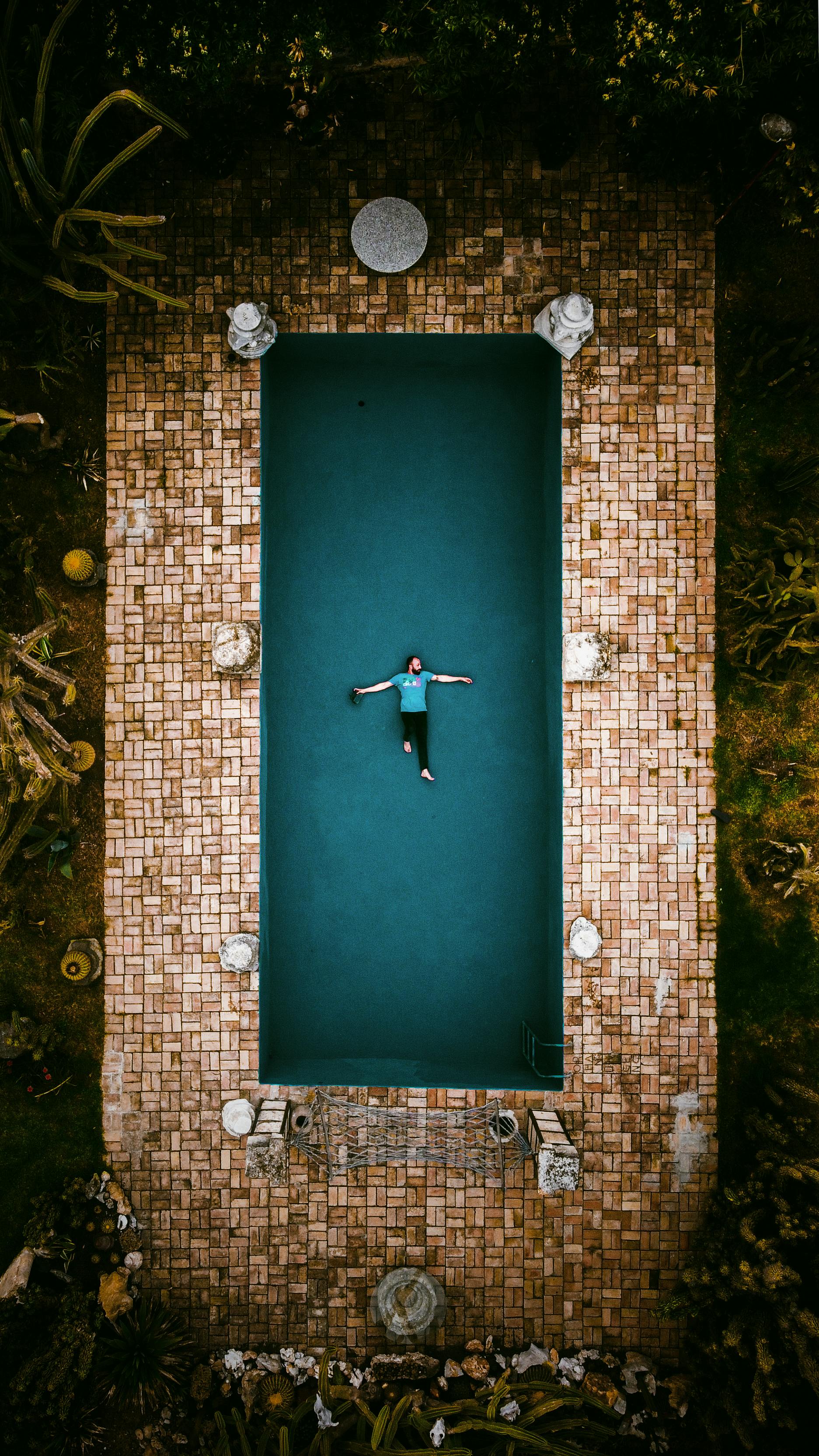 Top View of Man Floating in the Pool · Free Stock Photo