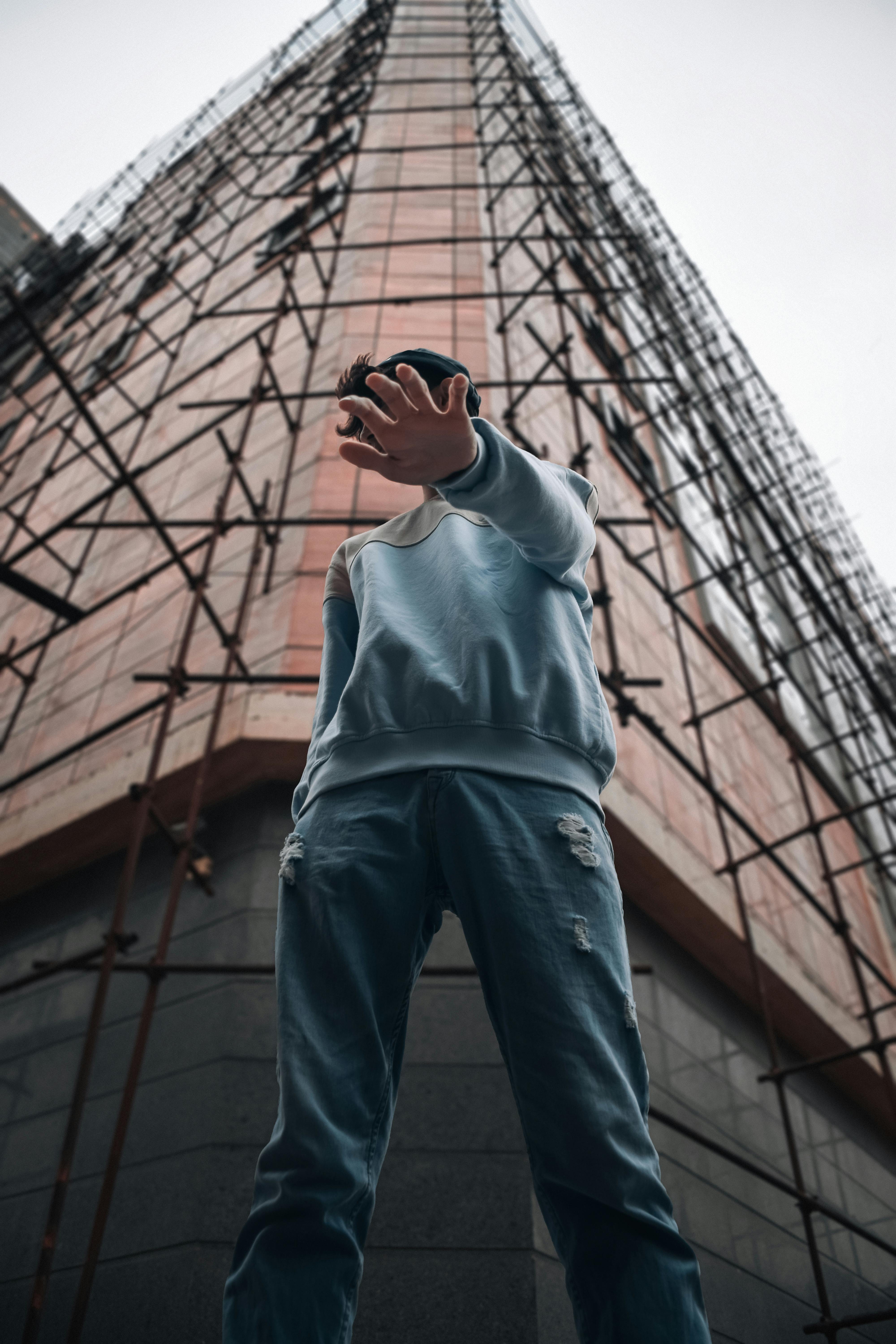 Low Angle Shot of a Man by a Building · Free Stock Photo