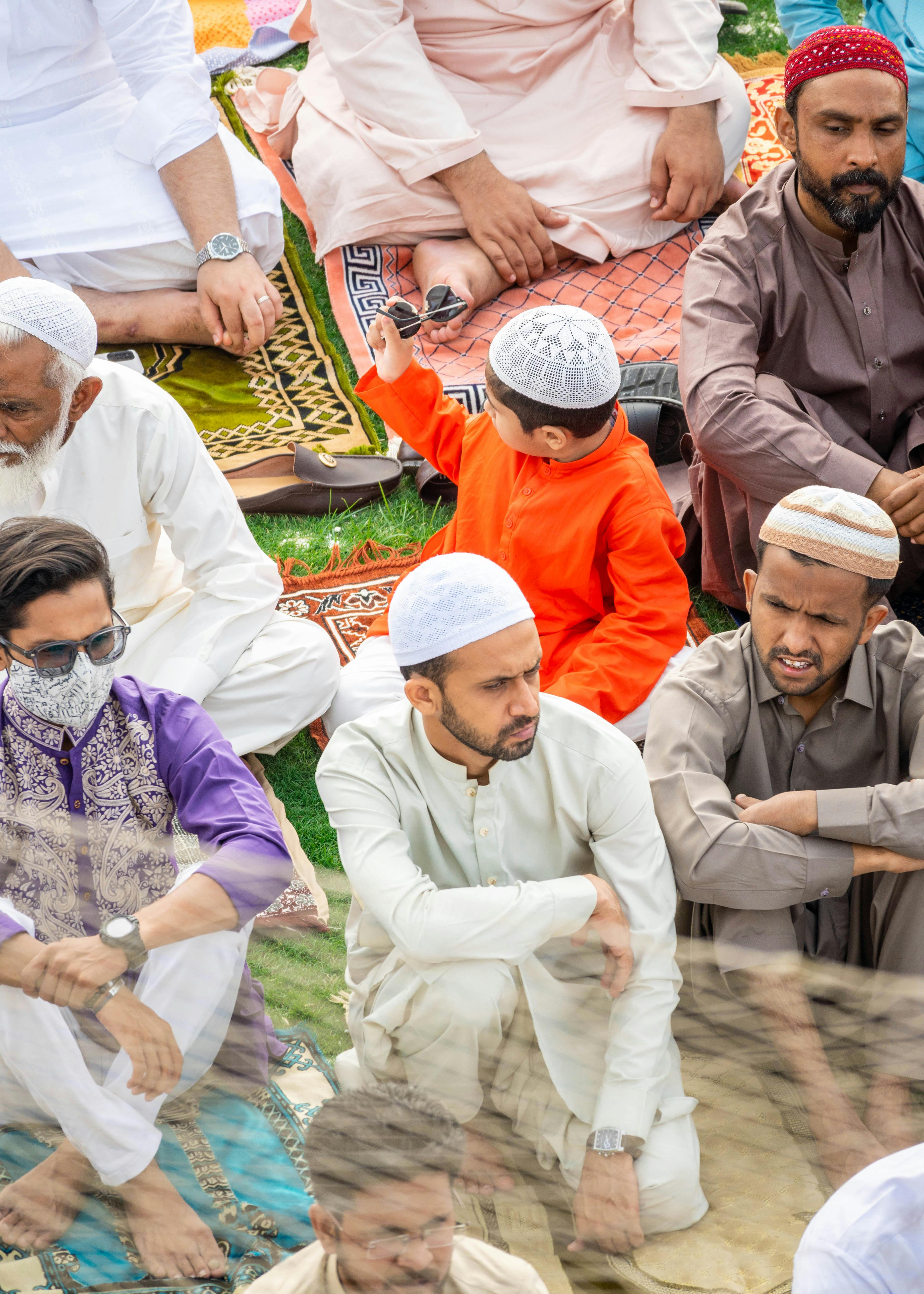 High Angle View of Muslim Men Sitting on Carpets · Free Stock Photo