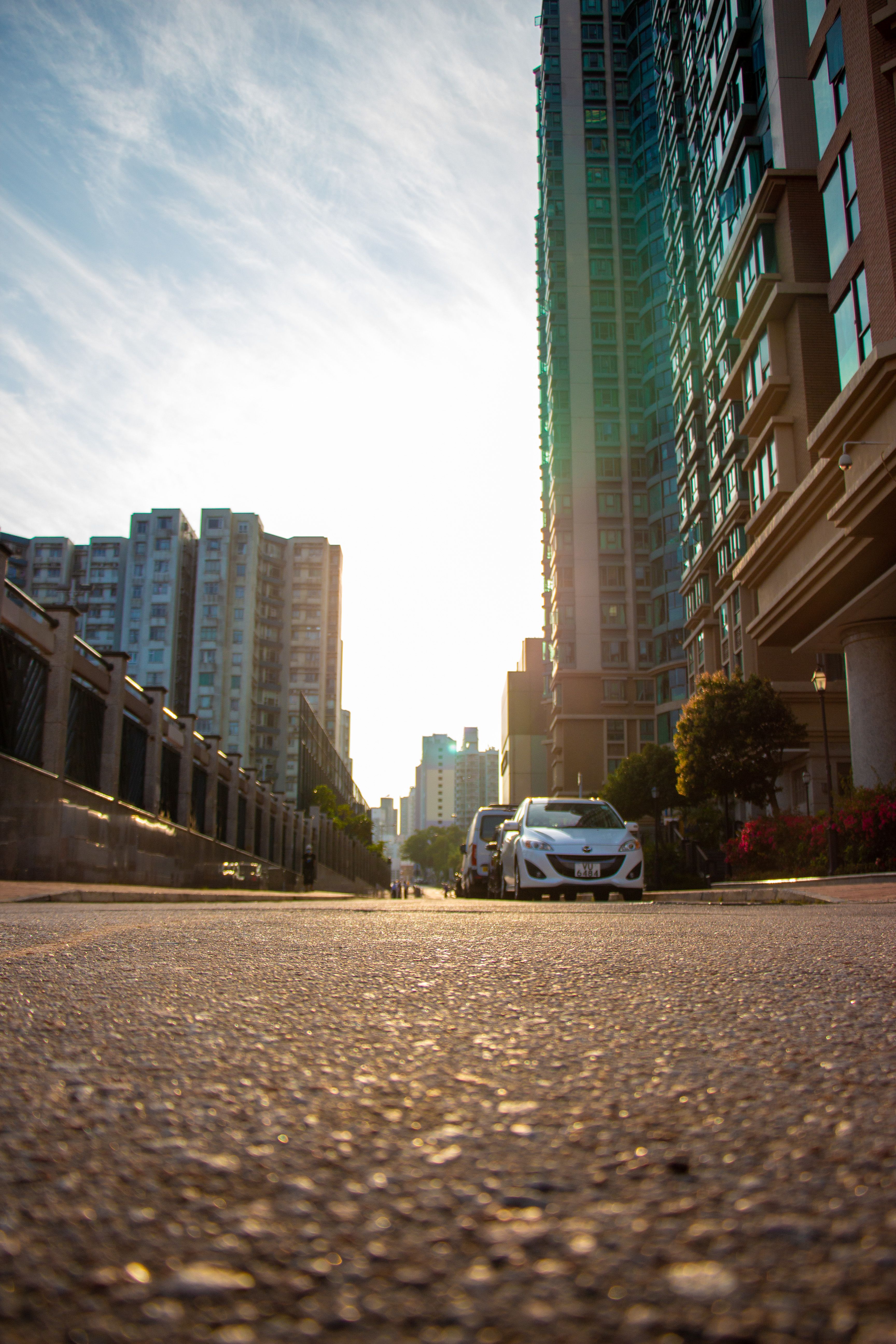 Cars Parked on Side of the Road Near High Rise Buildings · Free Stock Photo