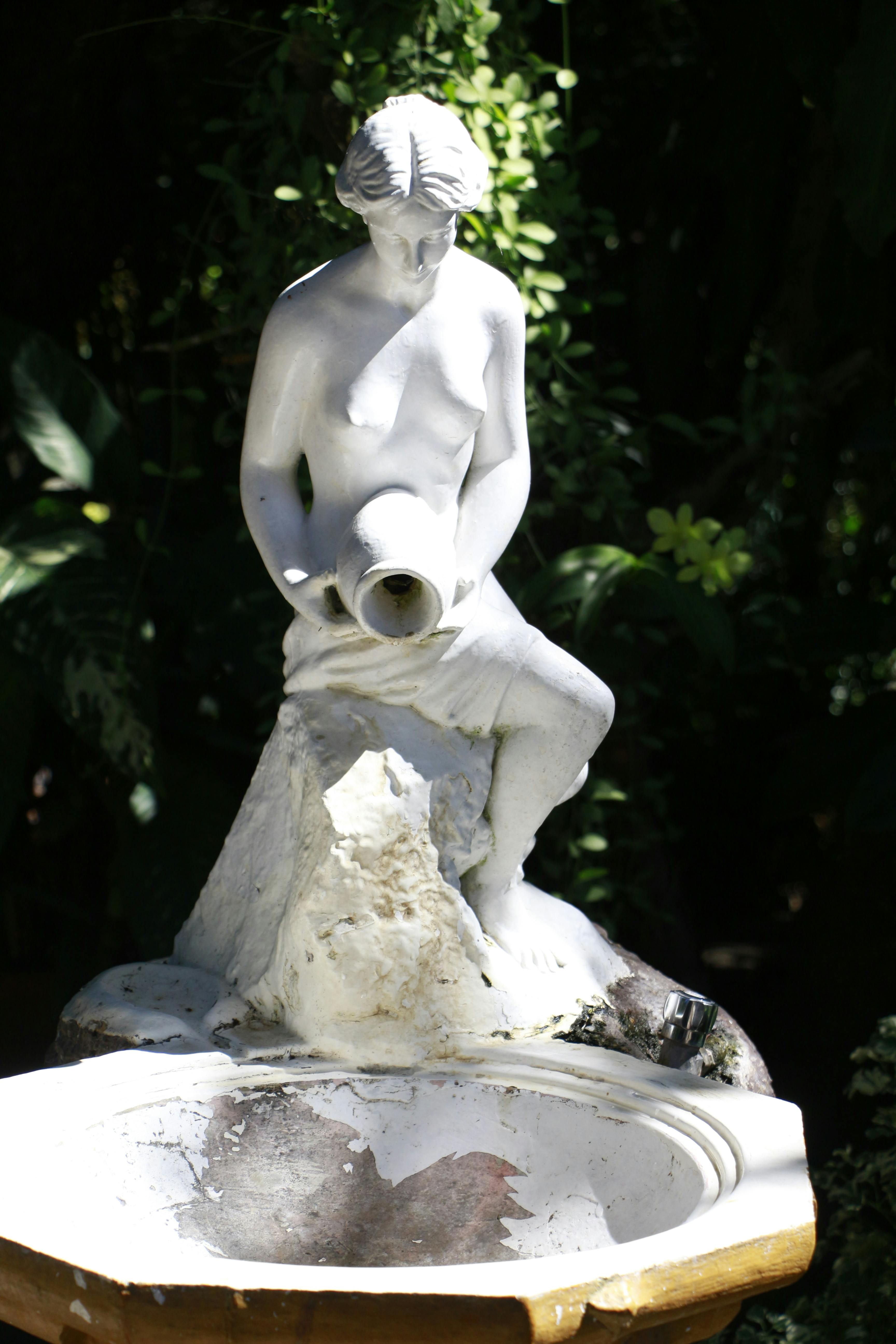 Fountain with a Statue of a Woman Holding a Pitcher · Free Stock Photo