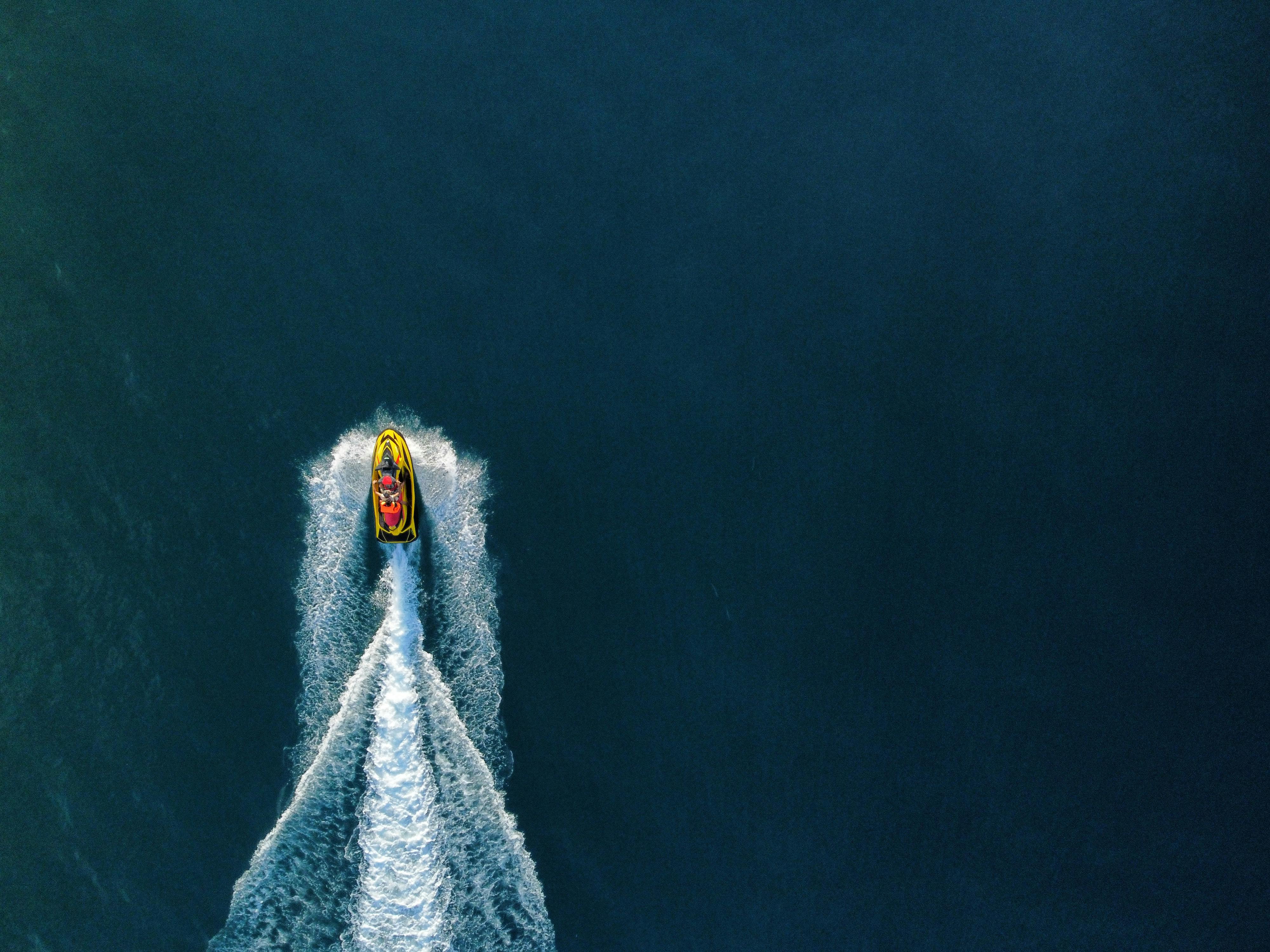 Top View Photo of Boat on Ocean · Free Stock Photo
