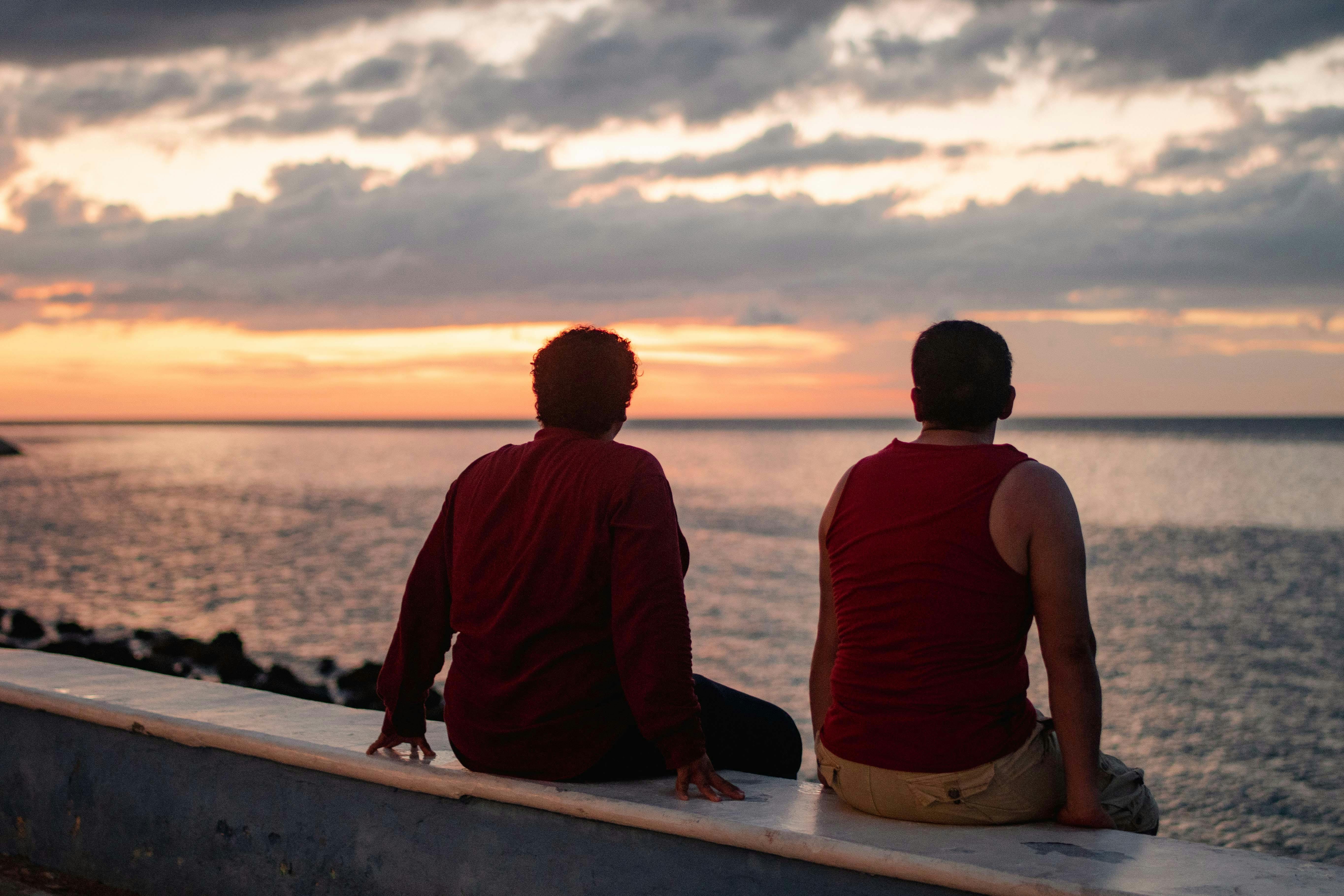 Men Sitting at the Seaside · Free Stock Photo