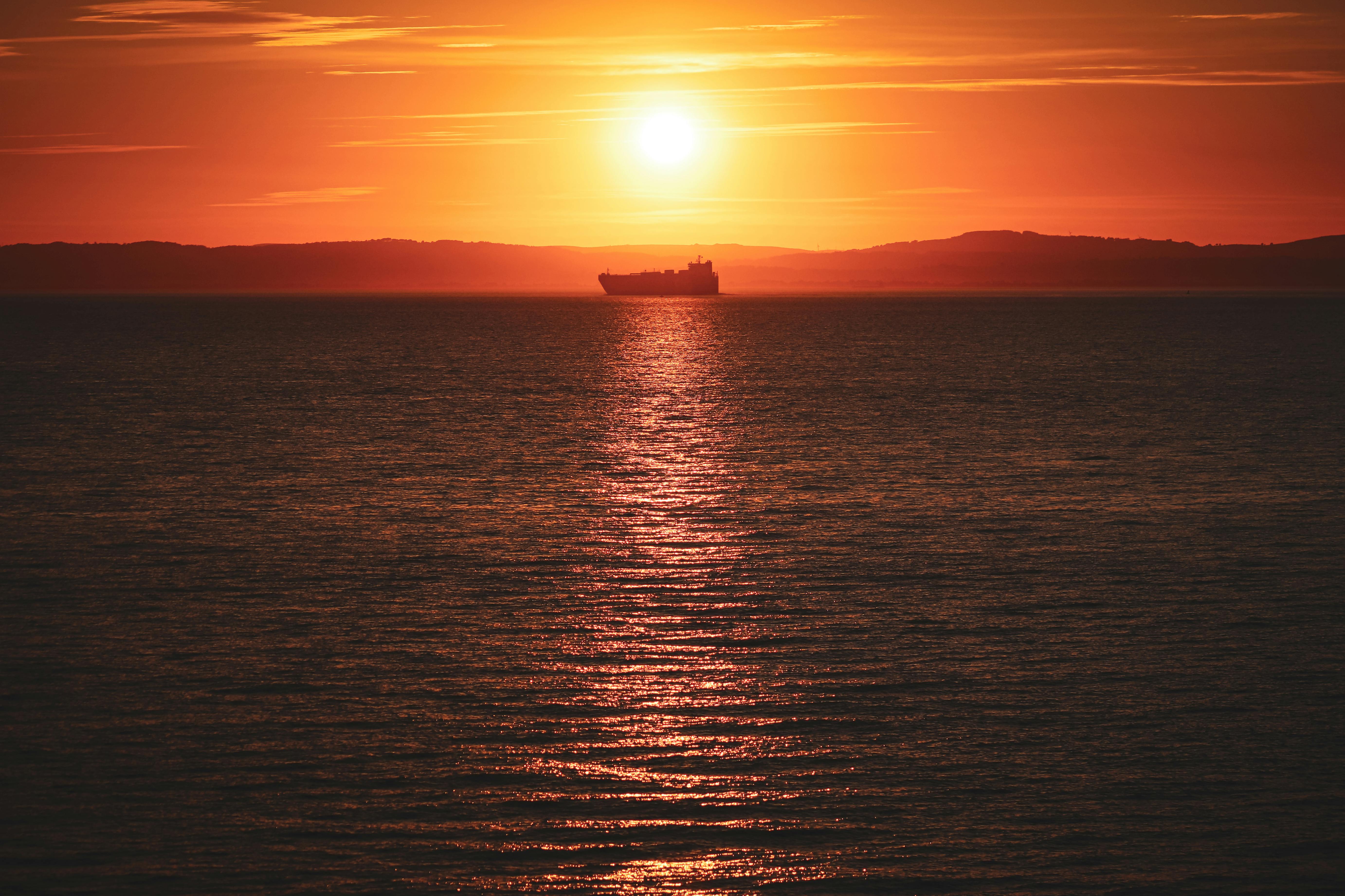Silhouette of Ship on Sea during Sunset · Free Stock Photo