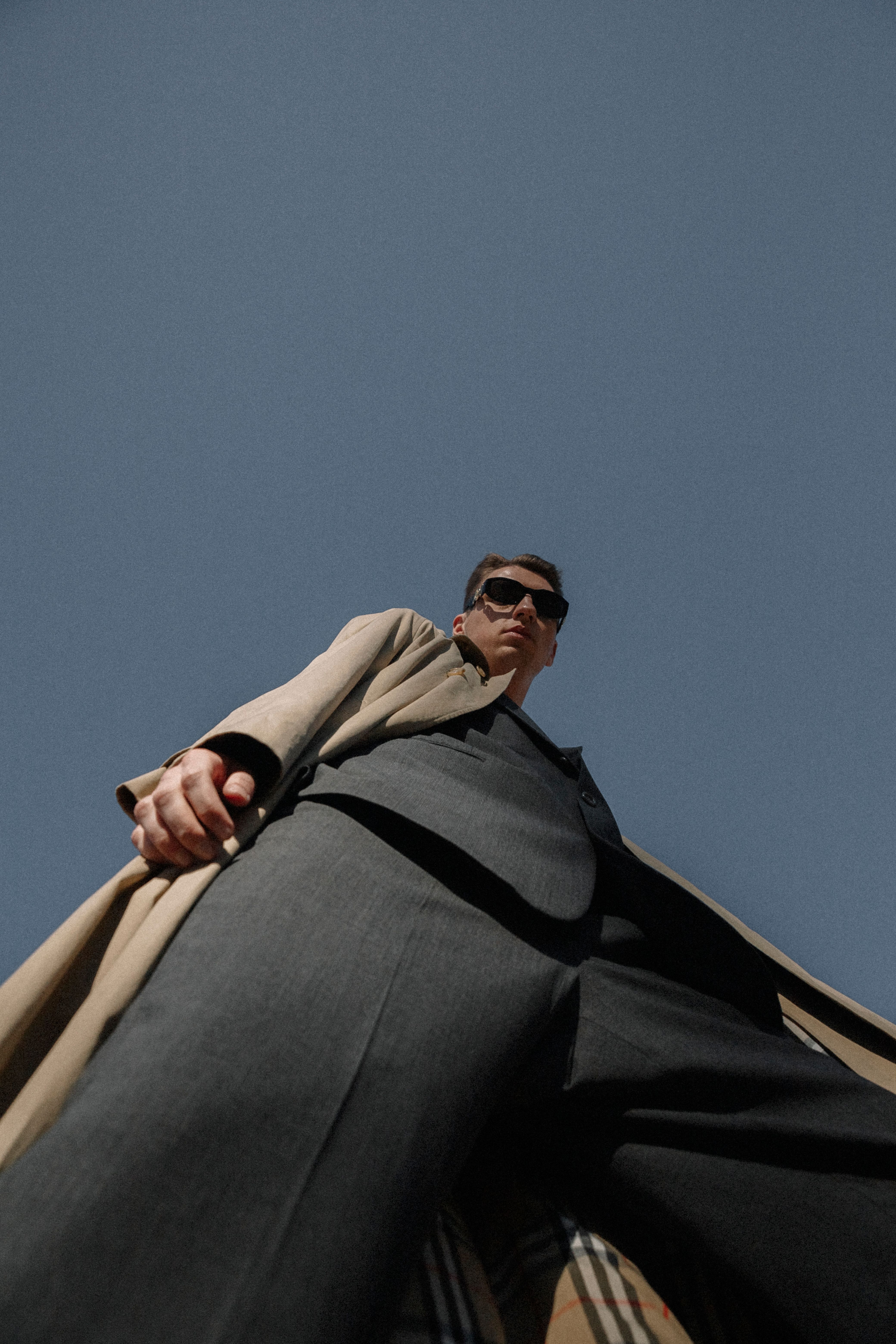 Low Angle Shot of a Man in Beige Trench Coat · Free Stock Photo
