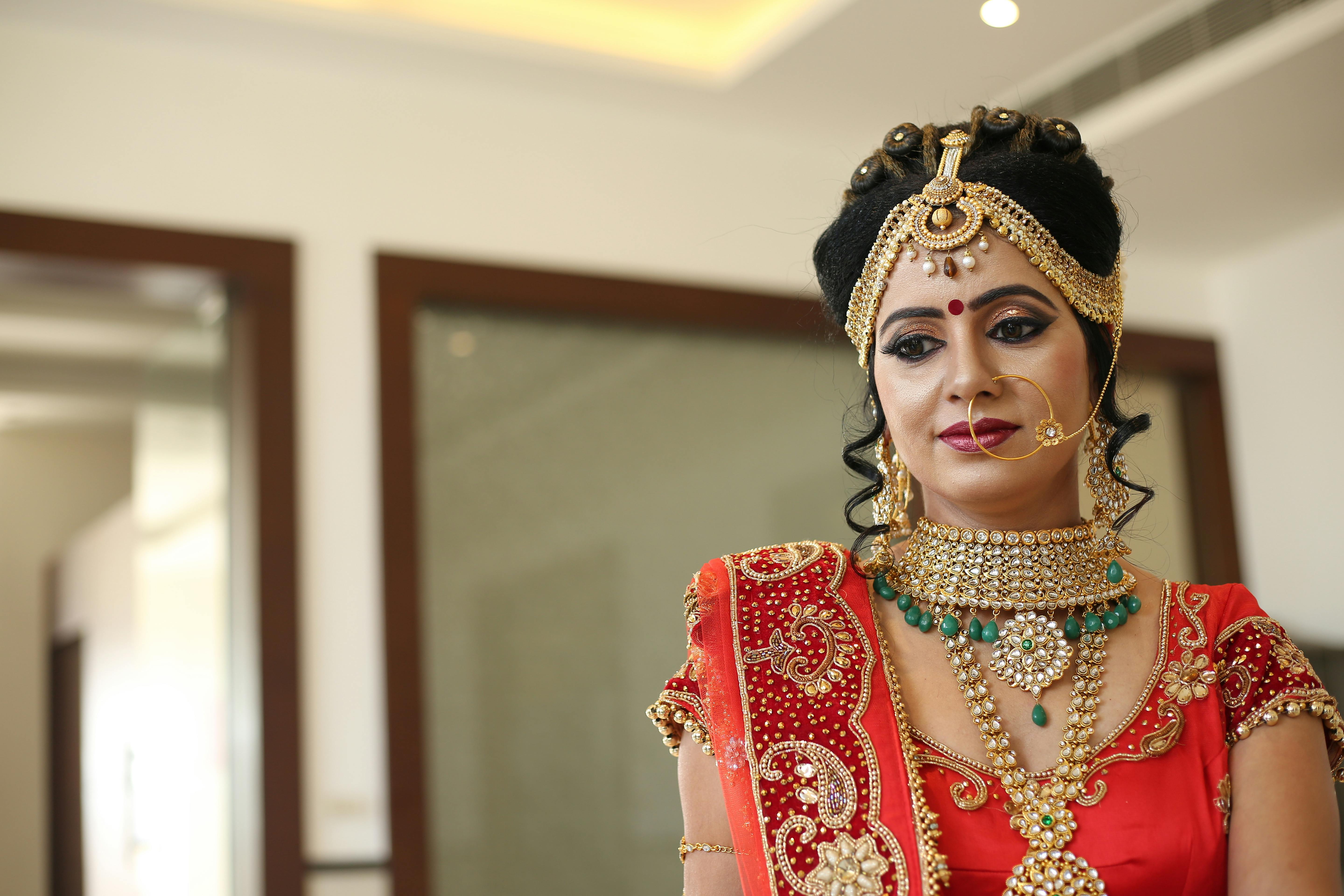 A Woman in Red and Gold Saree · Free Stock Photo