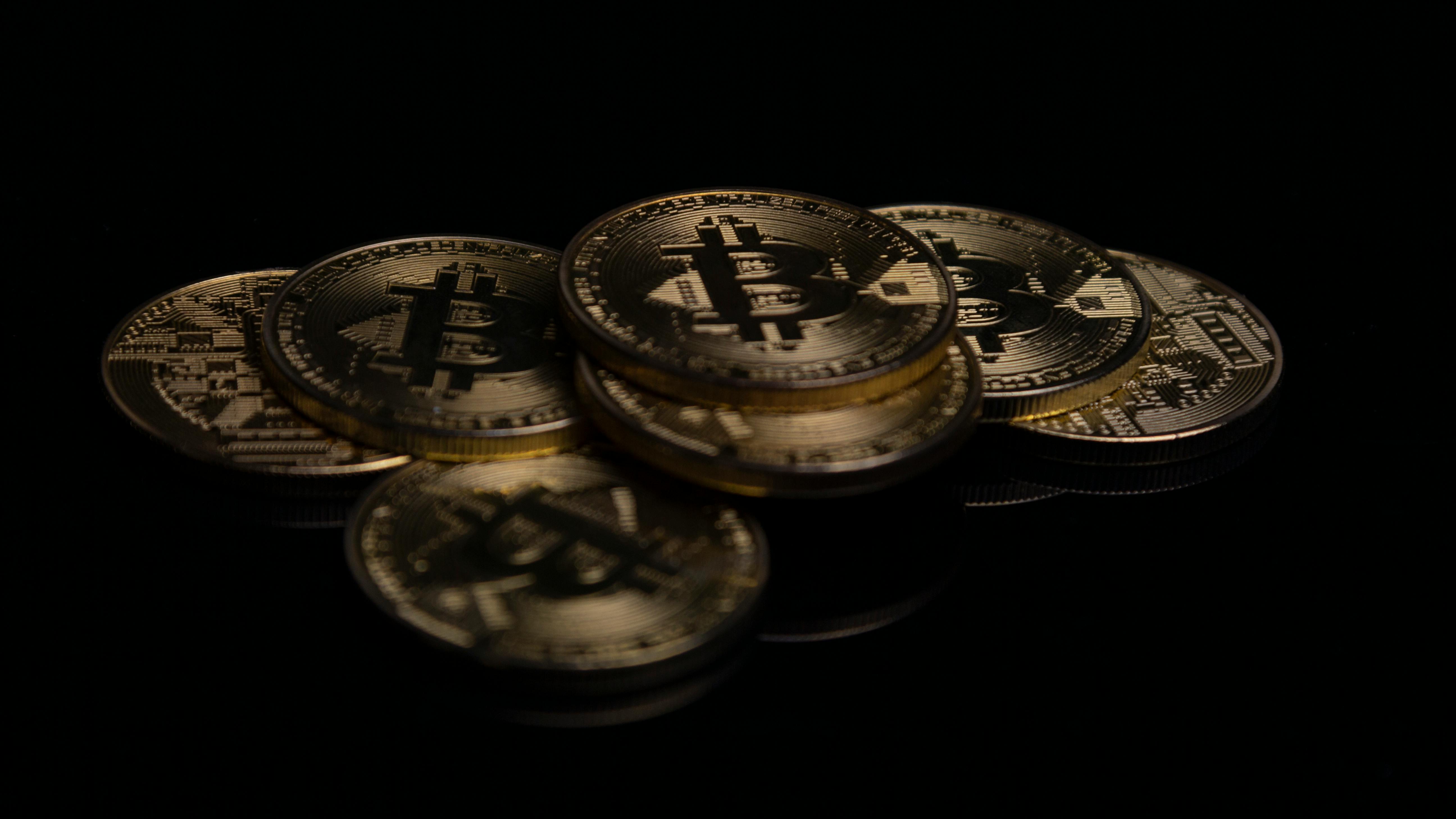Close-Up Shot of Bitcoins on Black Surface · Free Stock Photo
