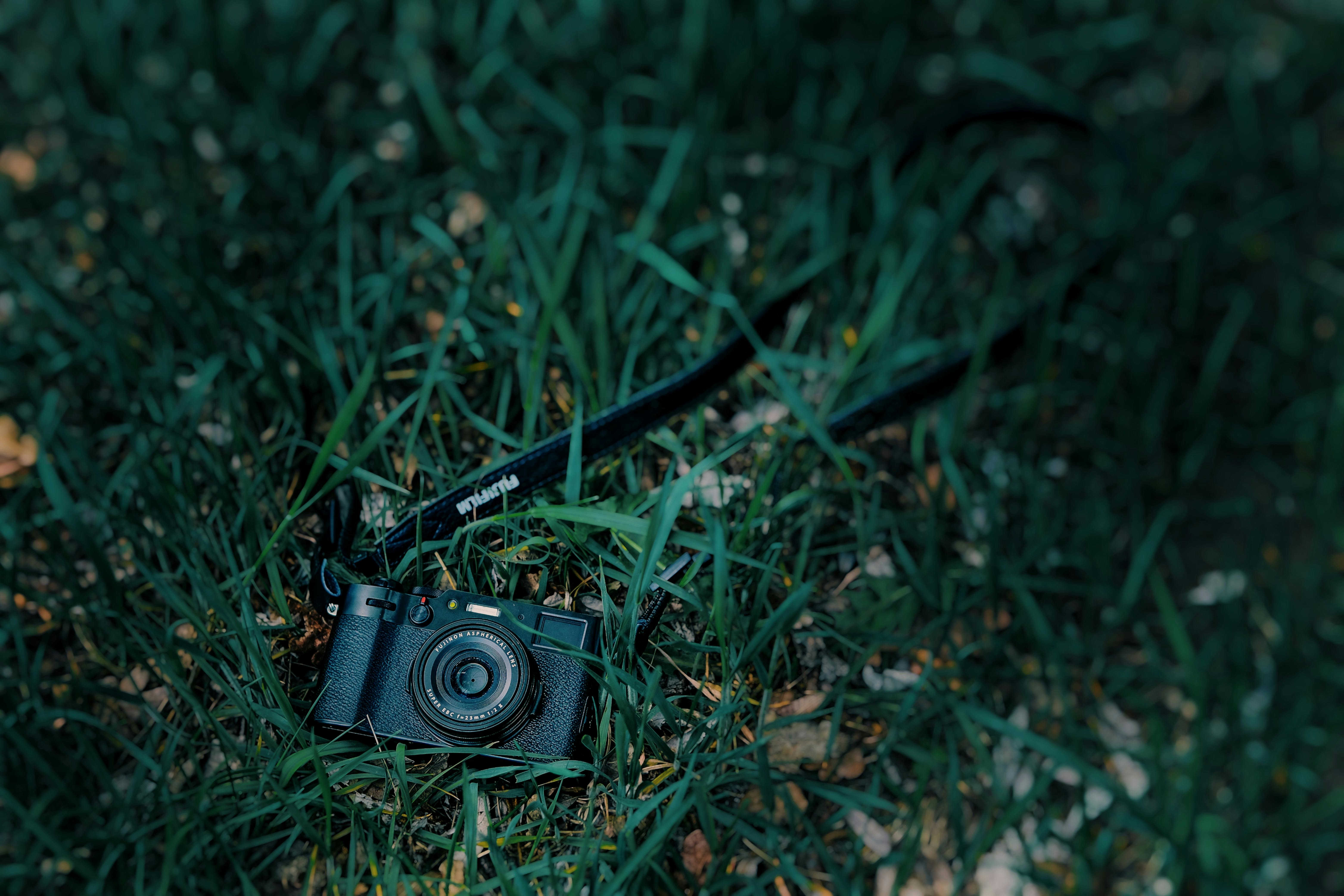 Black Camera on a Grassy Ground · Free Stock Photo
