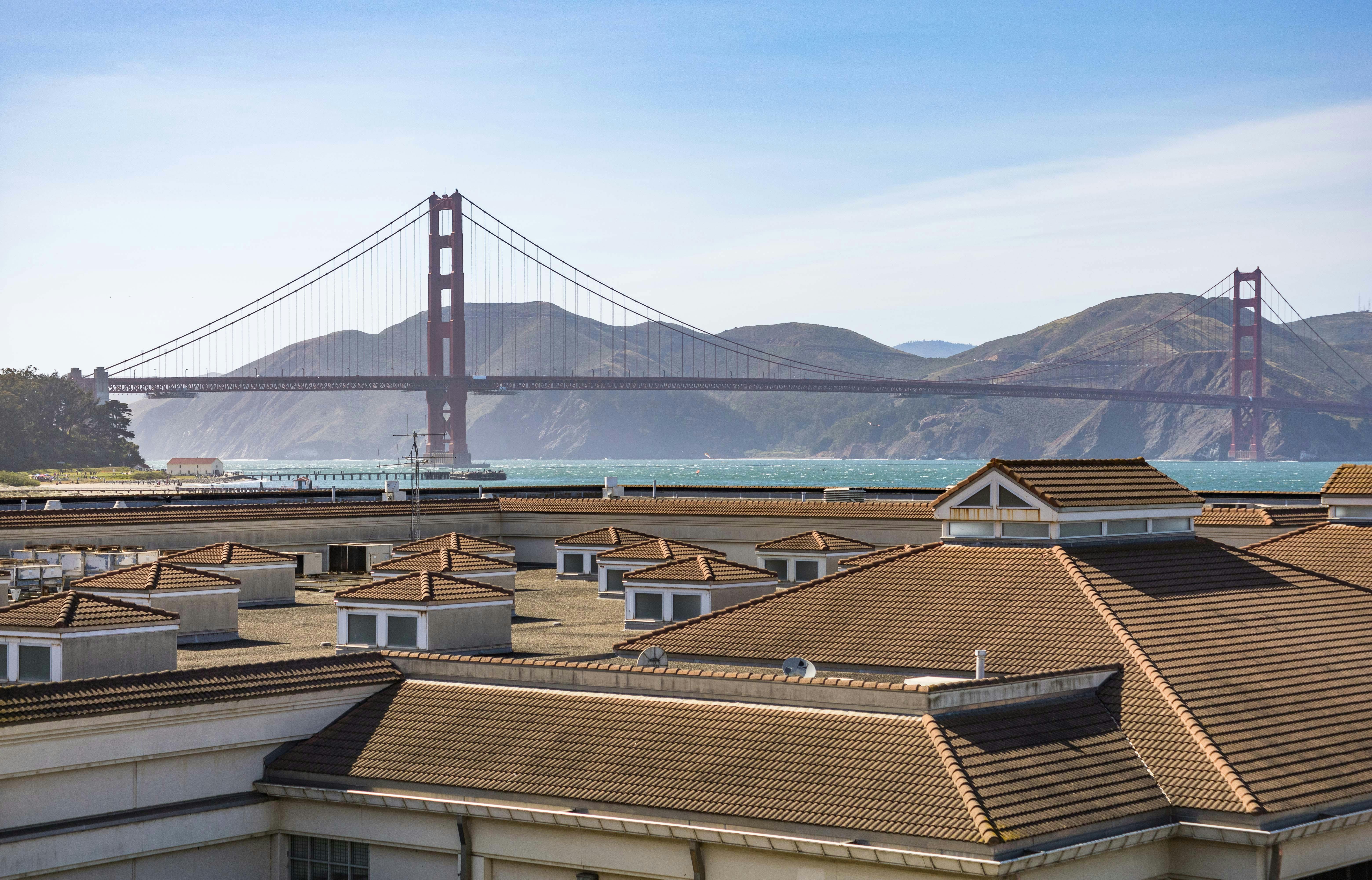 Brown and White Concrete Building Near Bridge Under Blue Sky · Free ...
