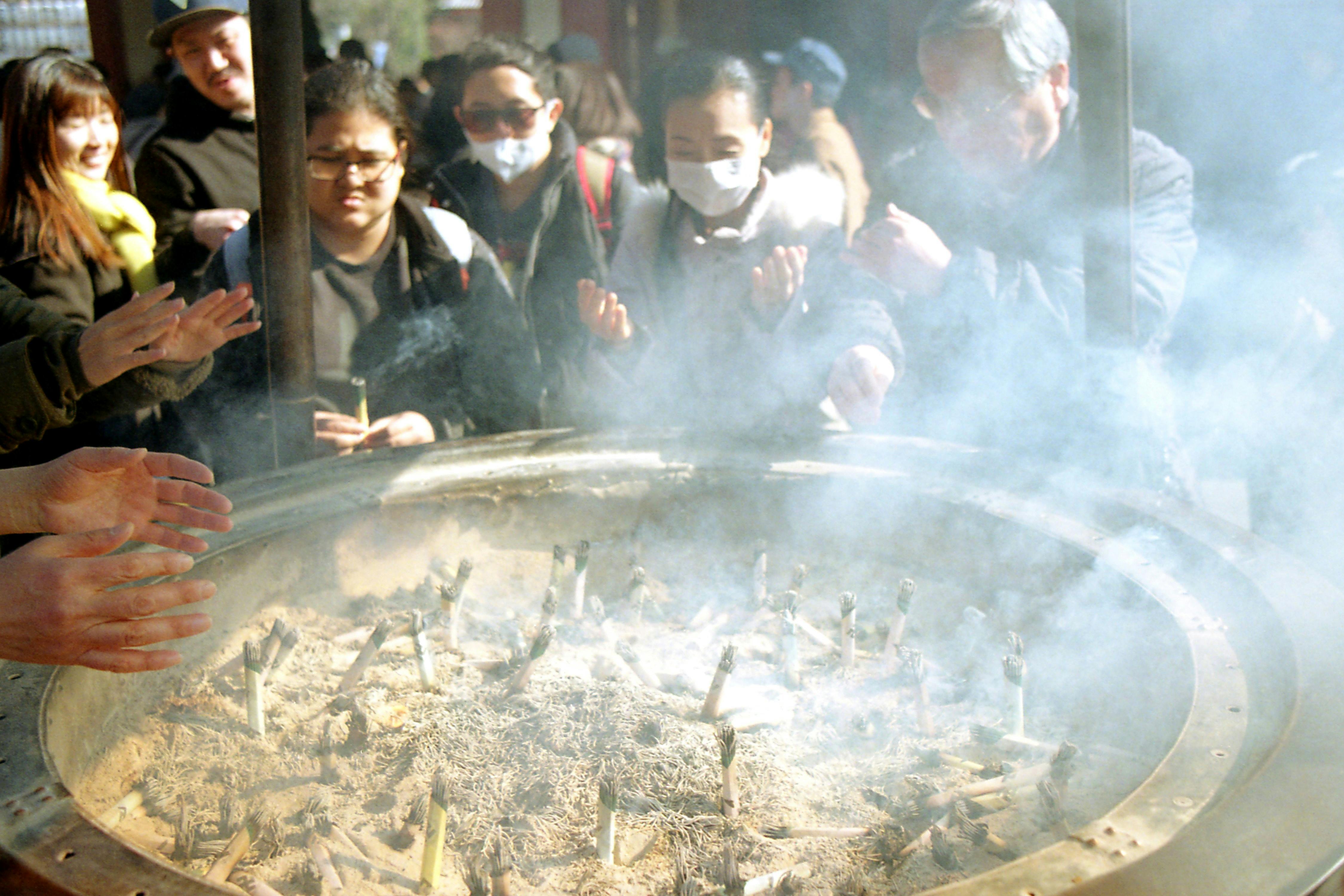People Warming Up on Street Heater · Free Stock Photo