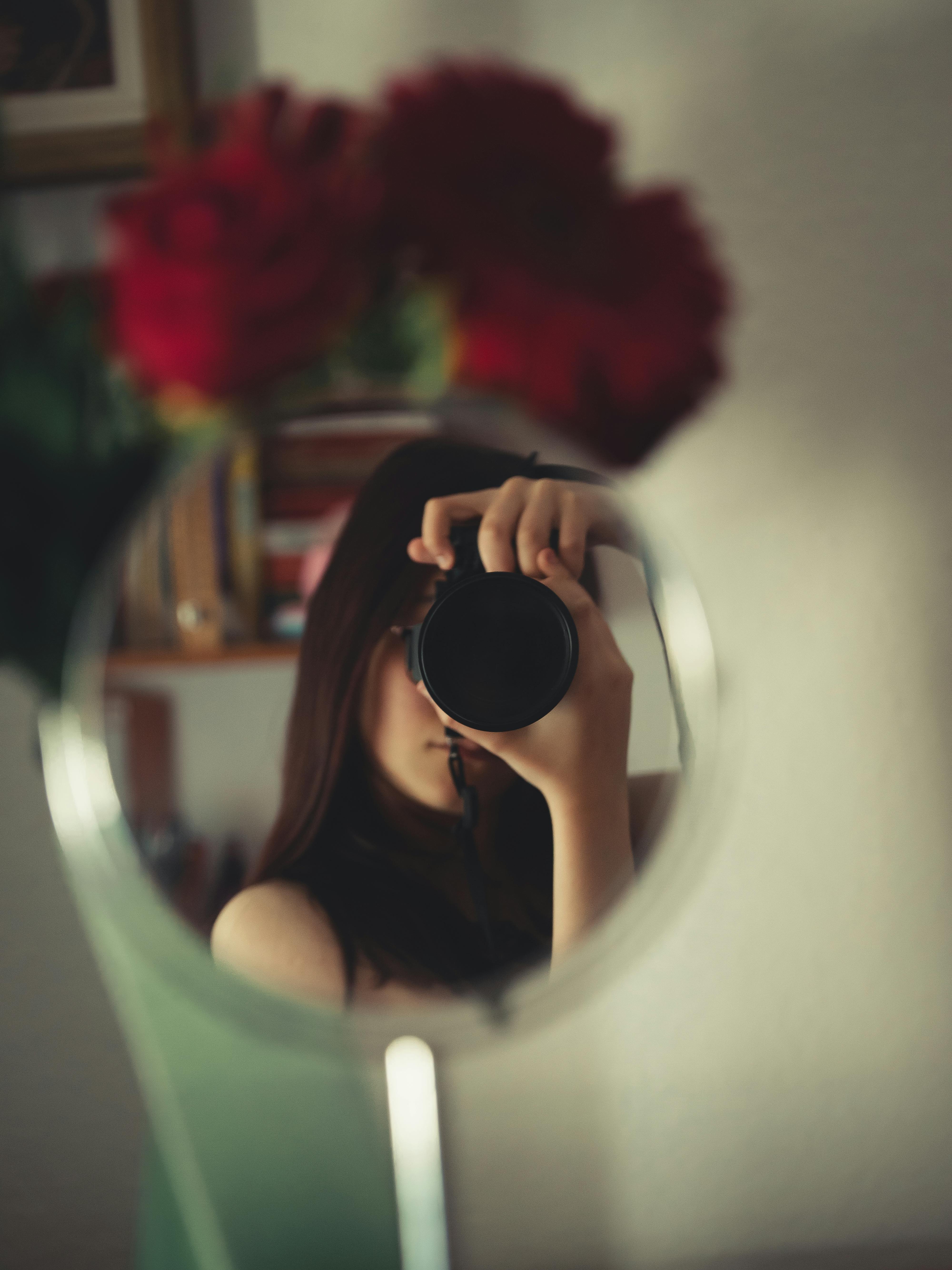 Person Reflect on Round Brown Wooden-framed Mirror · Free Stock Photo