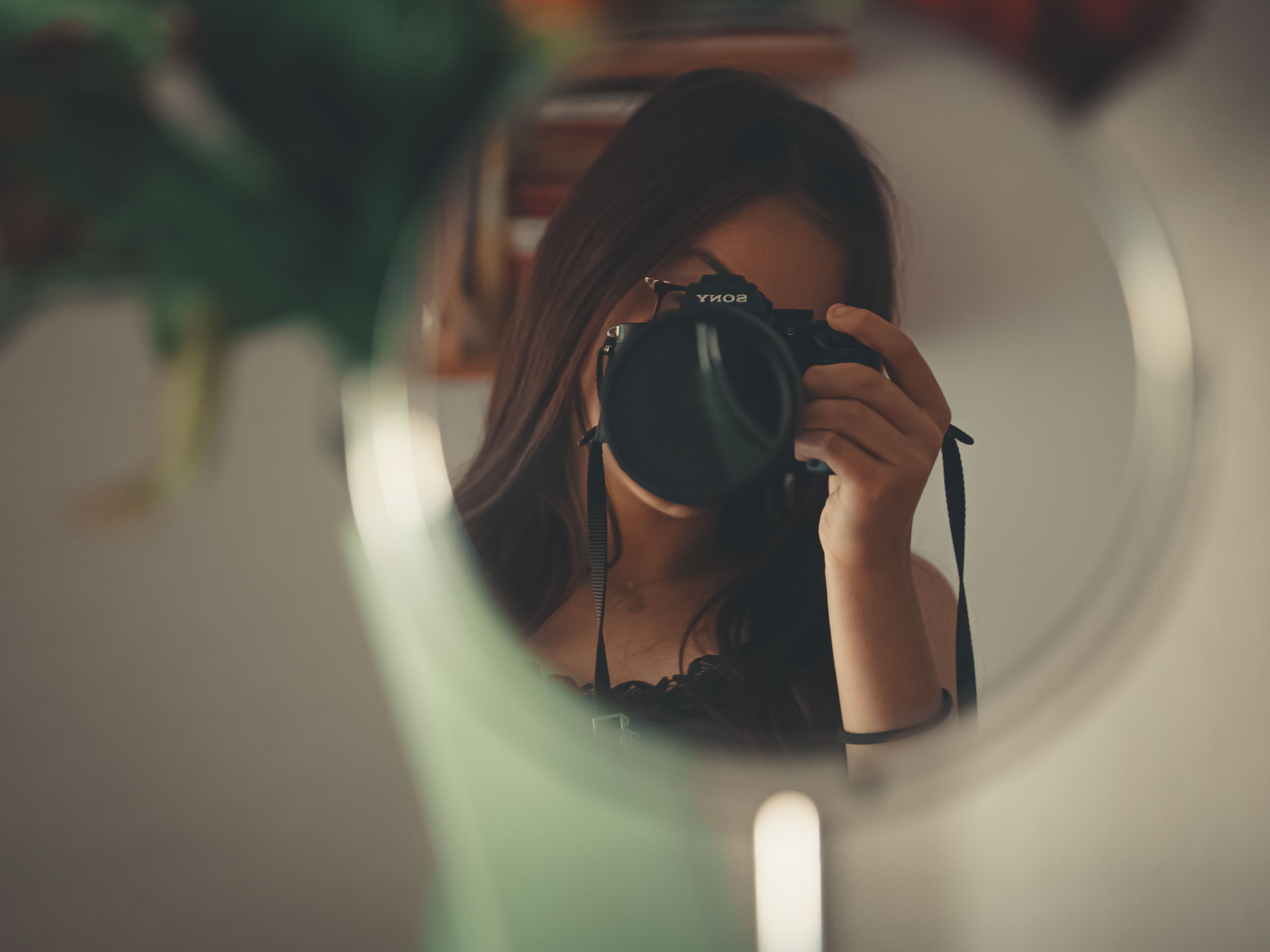Person Reflect on Round Brown Wooden-framed Mirror · Free Stock Photo