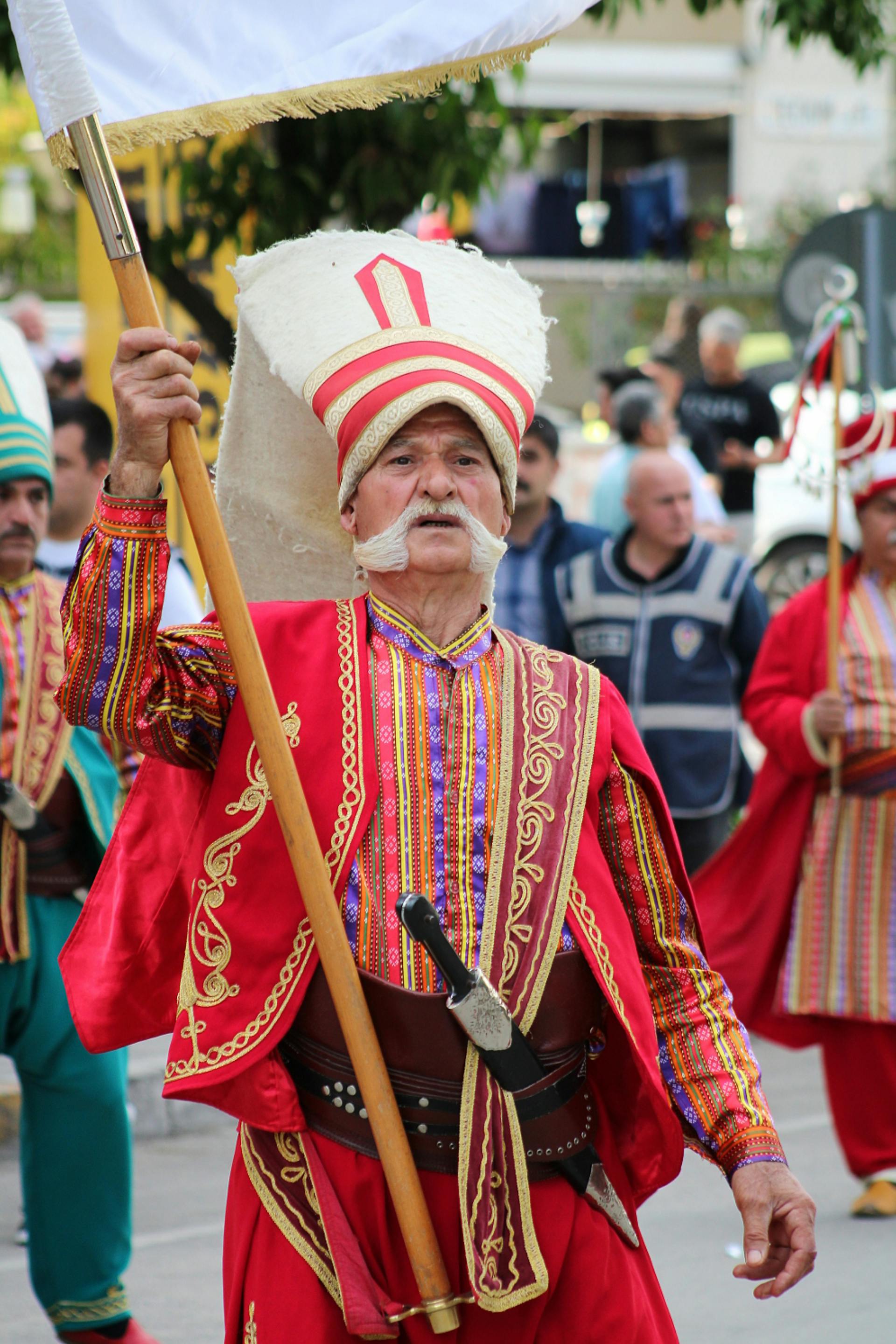A Man Carrying Gold and Red Statue · Free Stock Photo