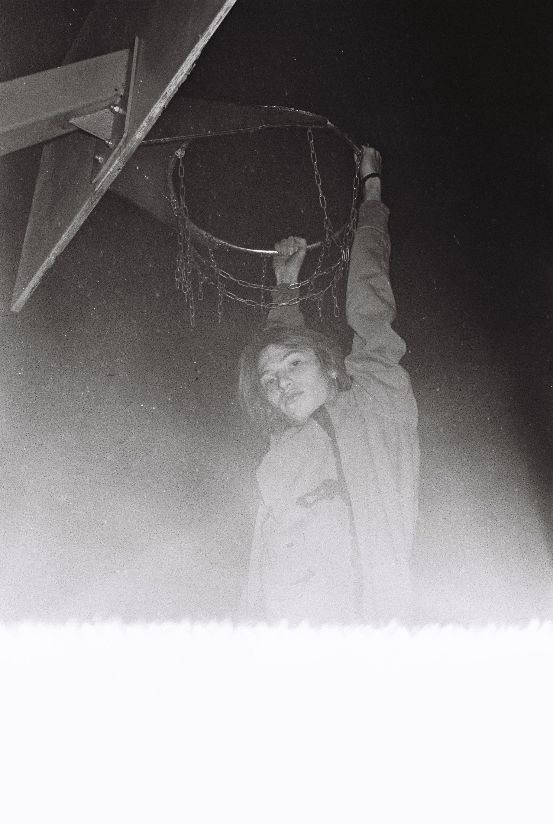 Woman Standing under a Basketball Hoop · Free Stock Photo