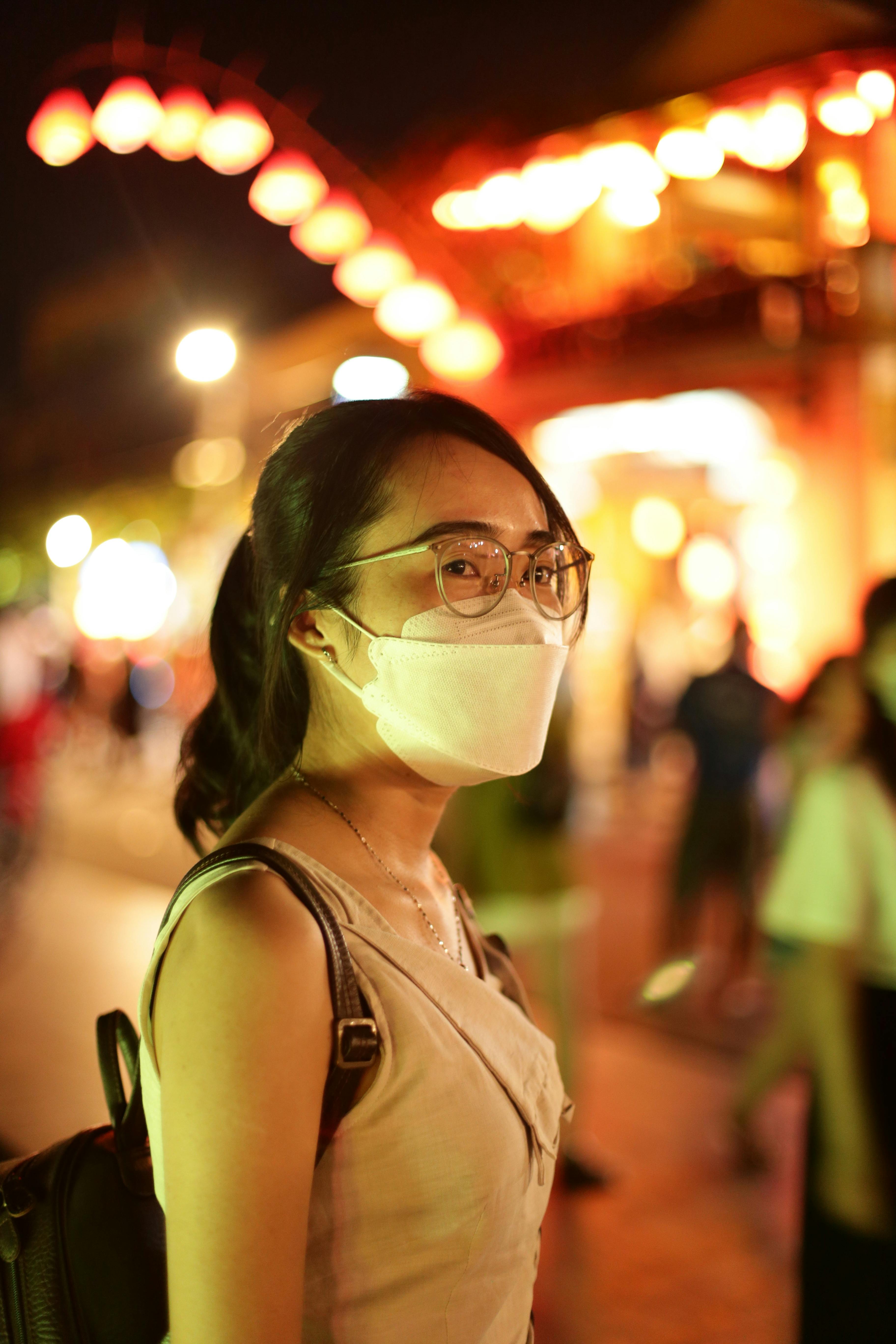 Woman with Flowers Taped on Shin Wearing a Pink Face Mask · Free Stock ...