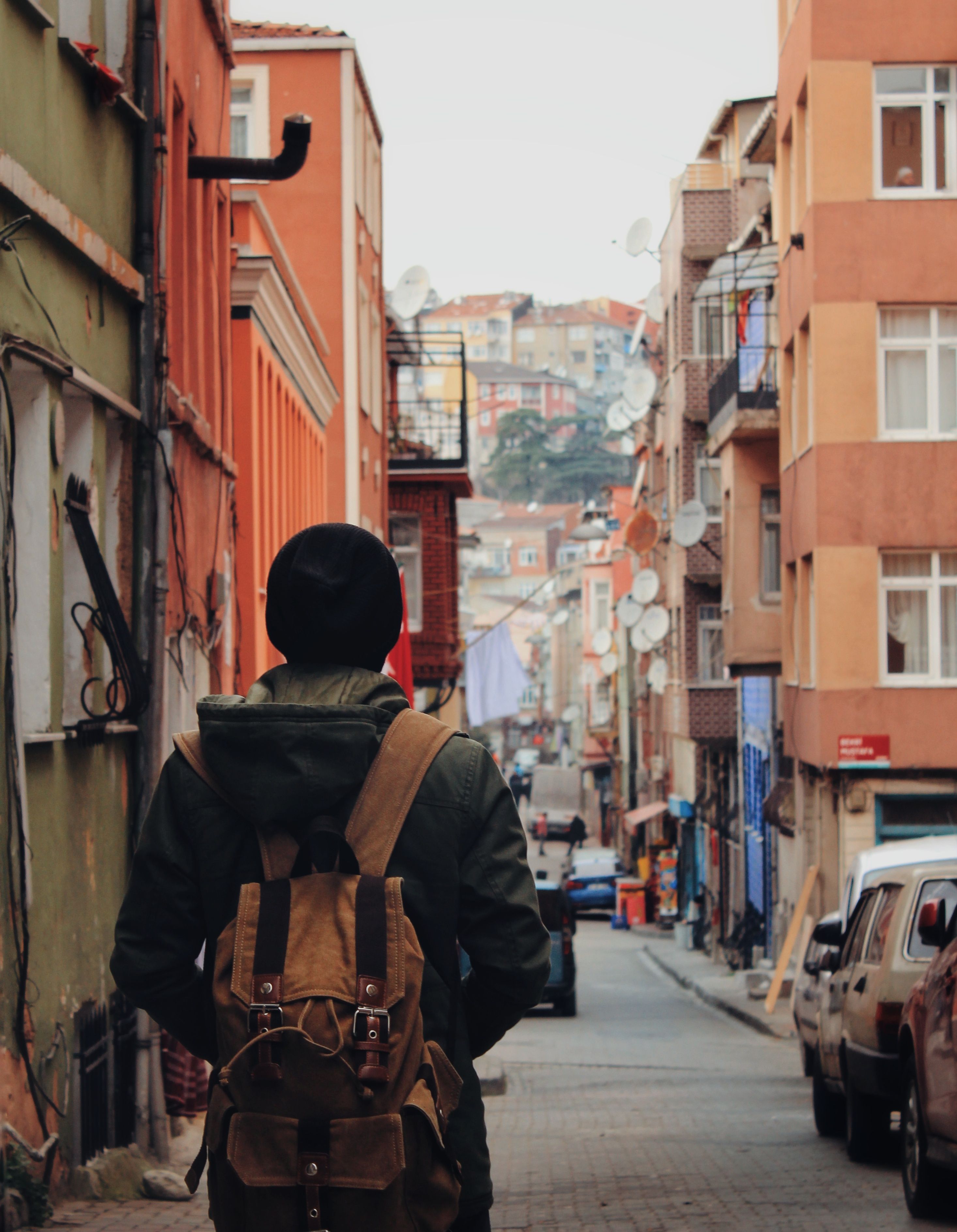 Back View of a Person Carrying a Backpack Walking on the Street · Free ...