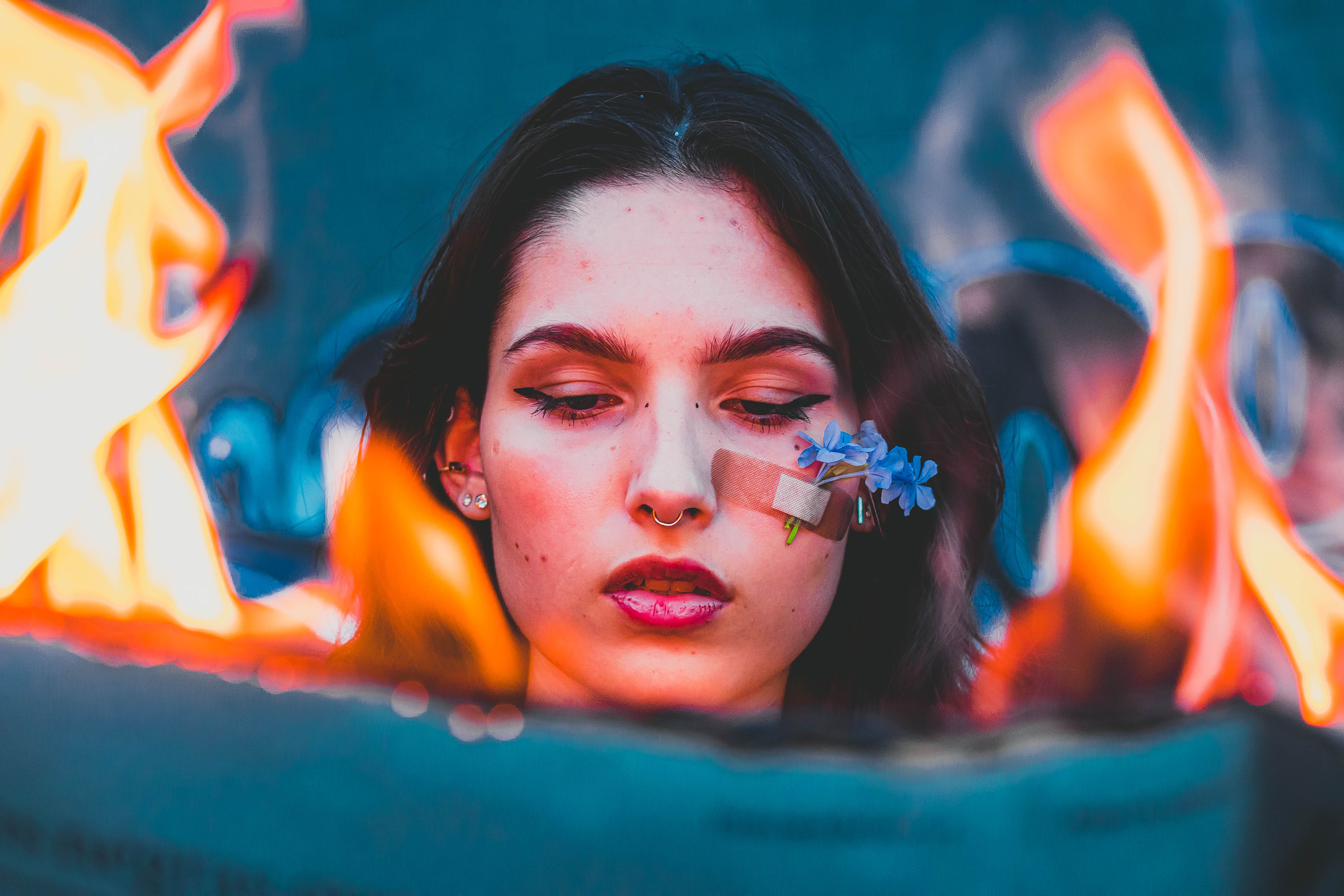 A Close-up Shot of a Woman with Band Aid and Flowers on Her Face · Free ...