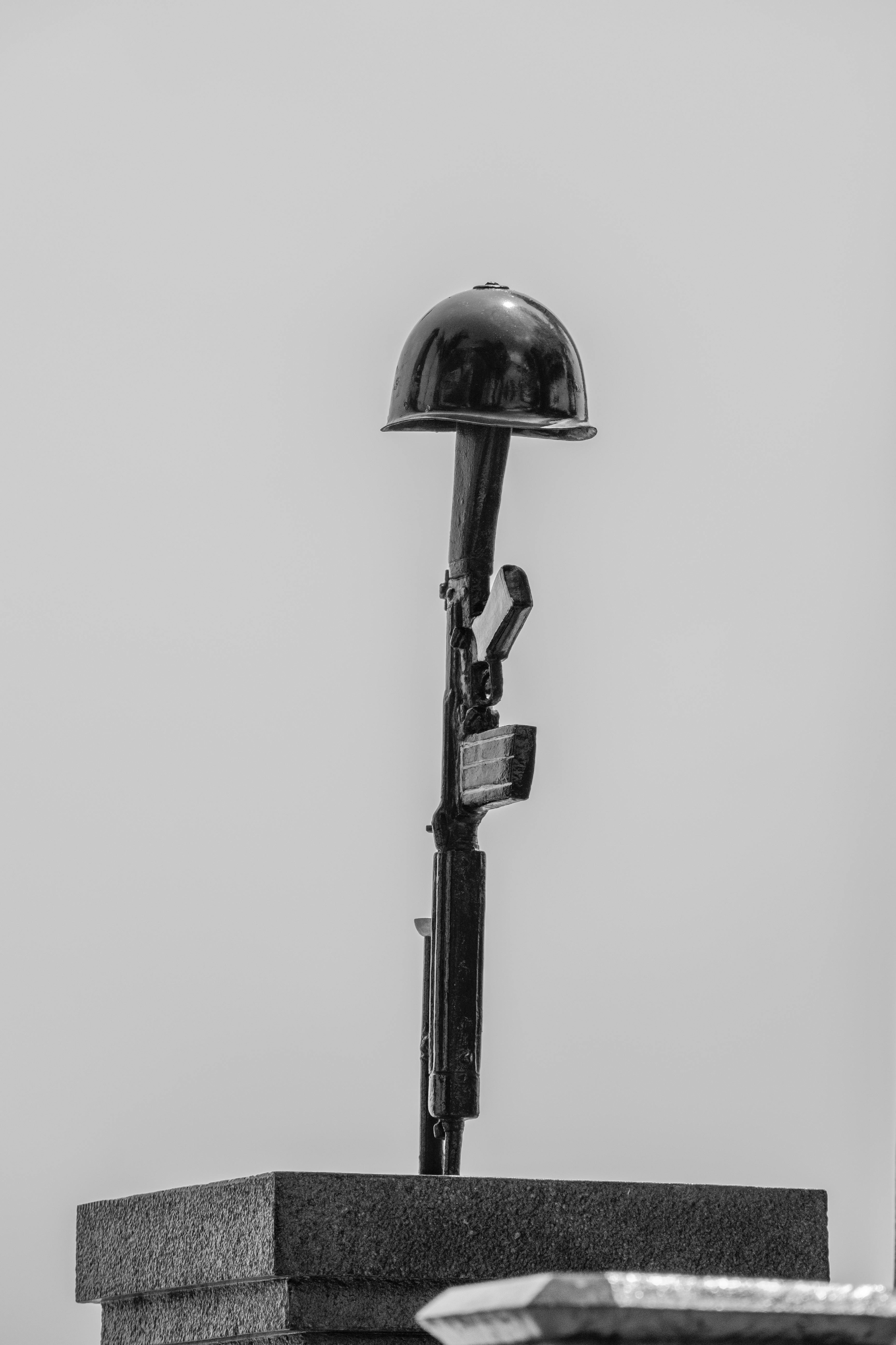 Helmet on Top of an Inverted Rifle · Free Stock Photo