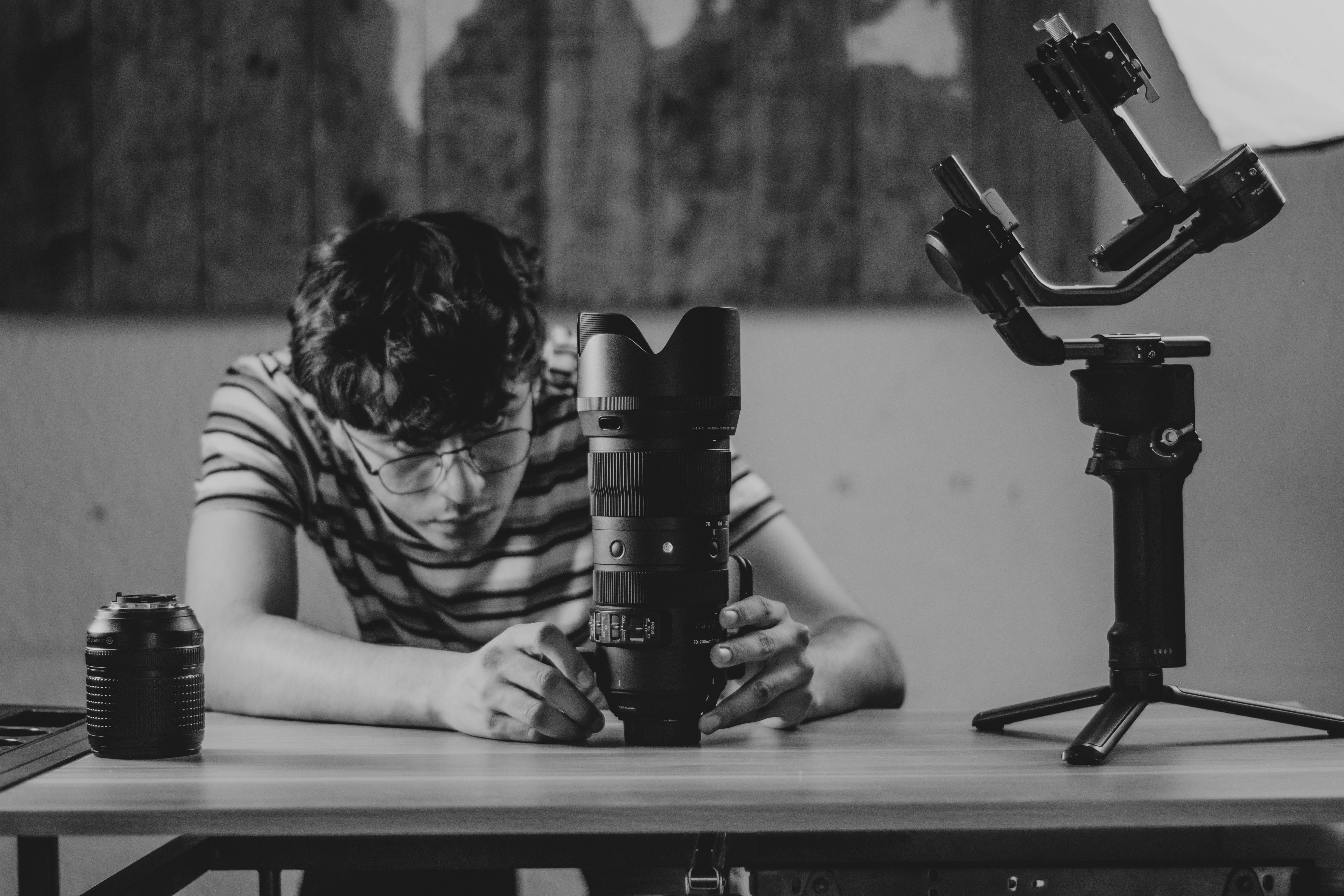 Man in Stripe Shirt Holding Camera Lens · Free Stock Photo