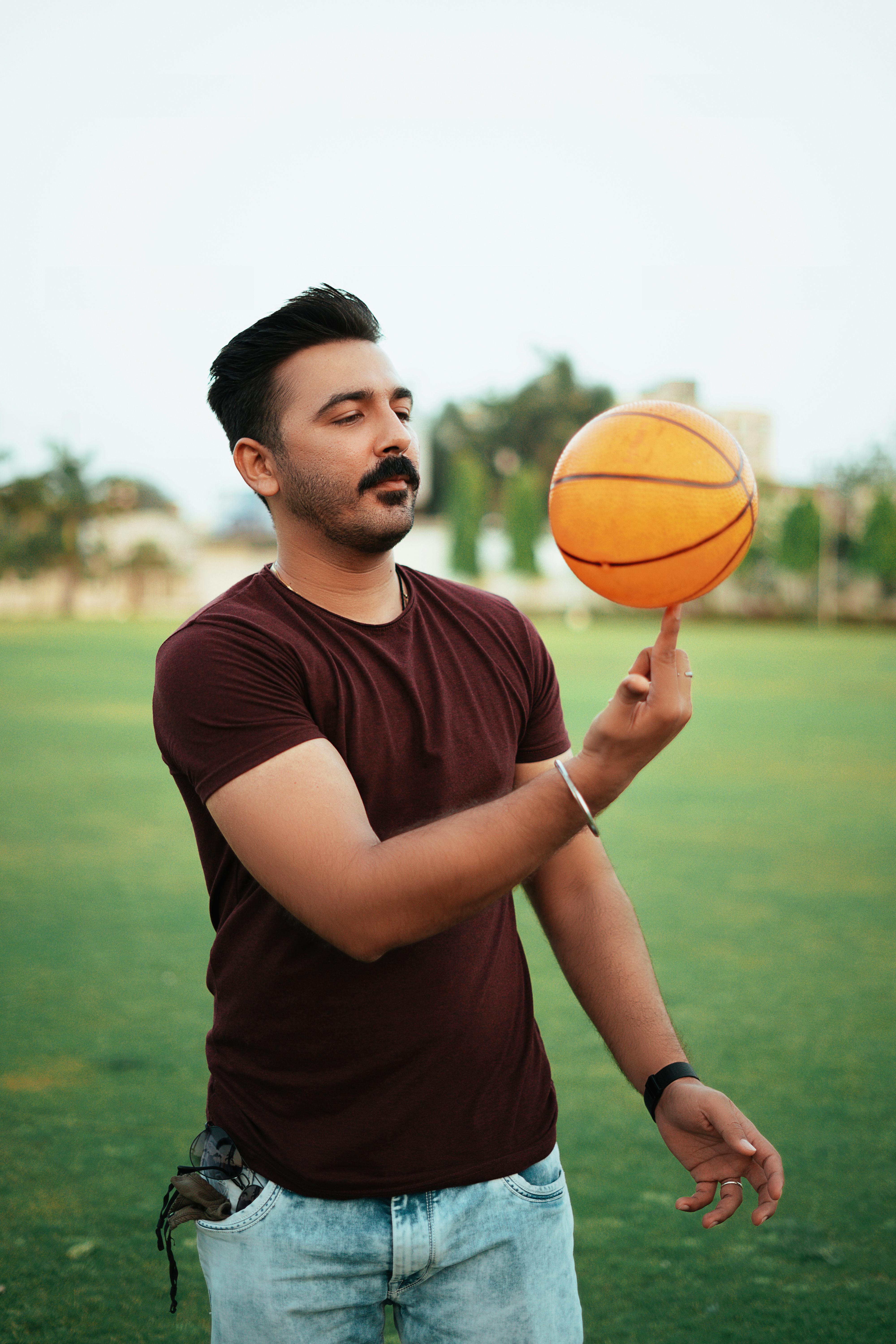 Man with a Mustache Playing with a Ball · Free Stock Photo