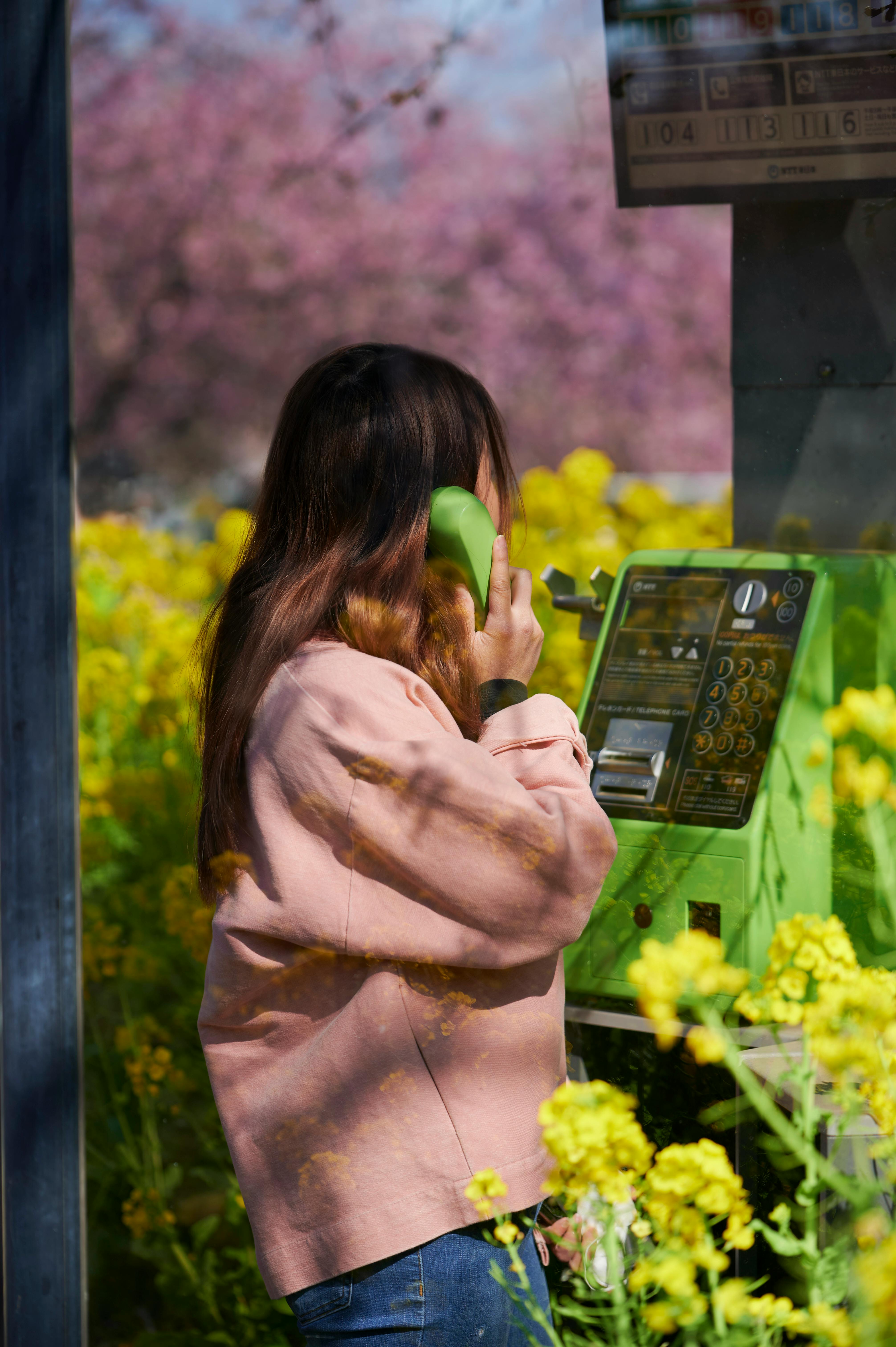A Phone Booth with Reflecting Neon Sign · Free Stock Photo