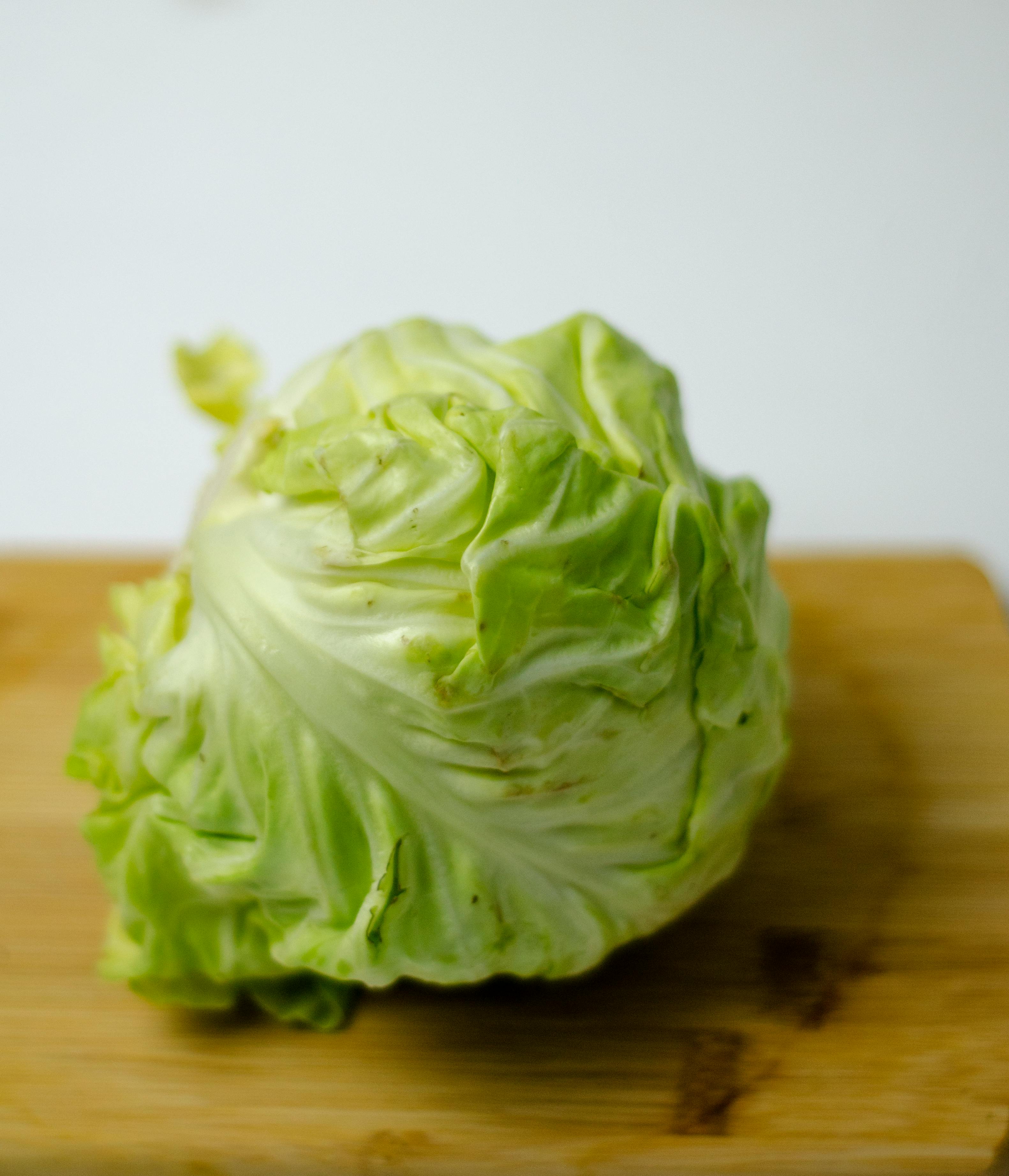 Close Up Photo of Cabbage on Wooden Chopping Board · Free Stock Photo