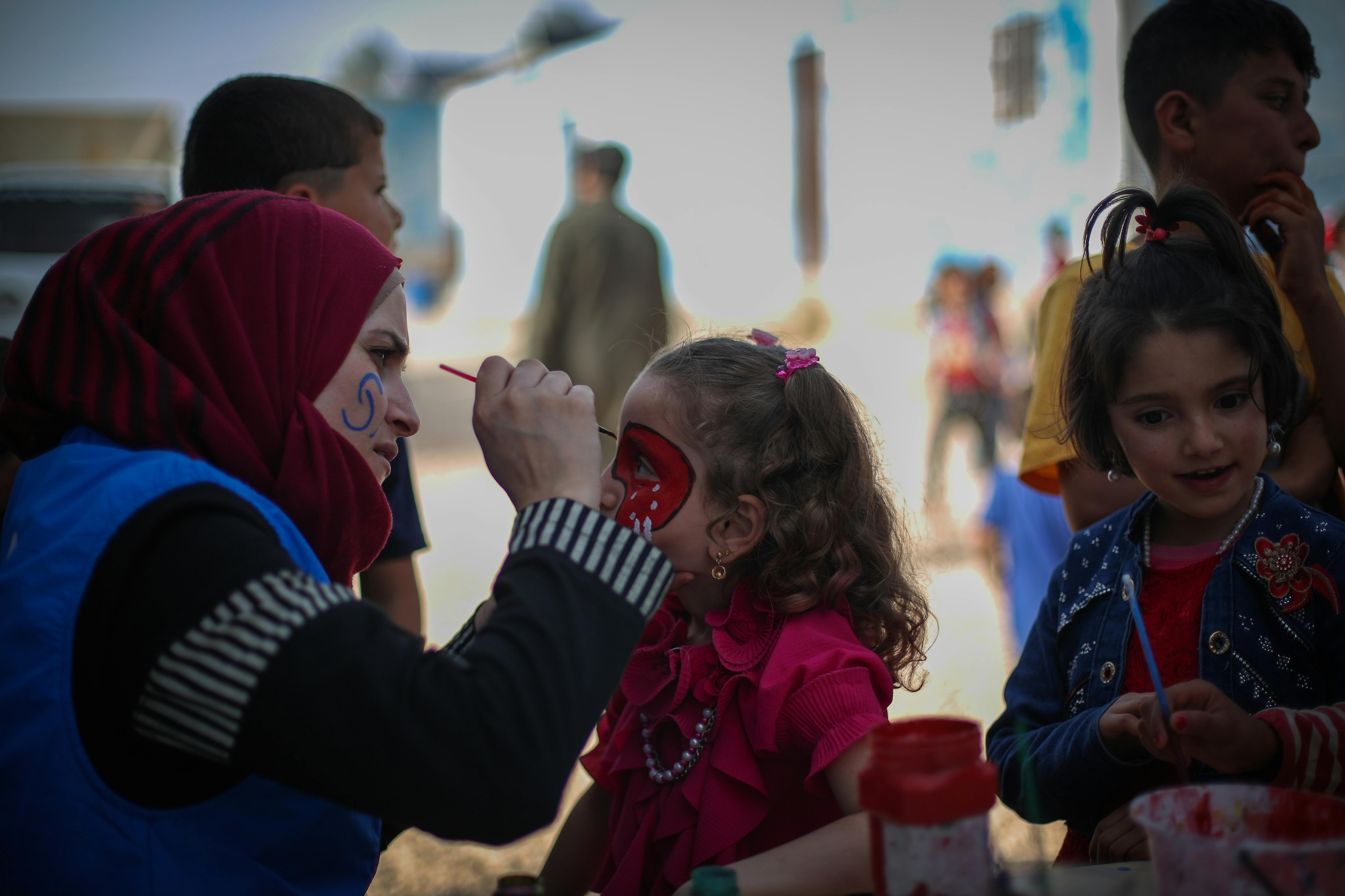 Woman Putting Face Paint to a Girl · Free Stock Photo