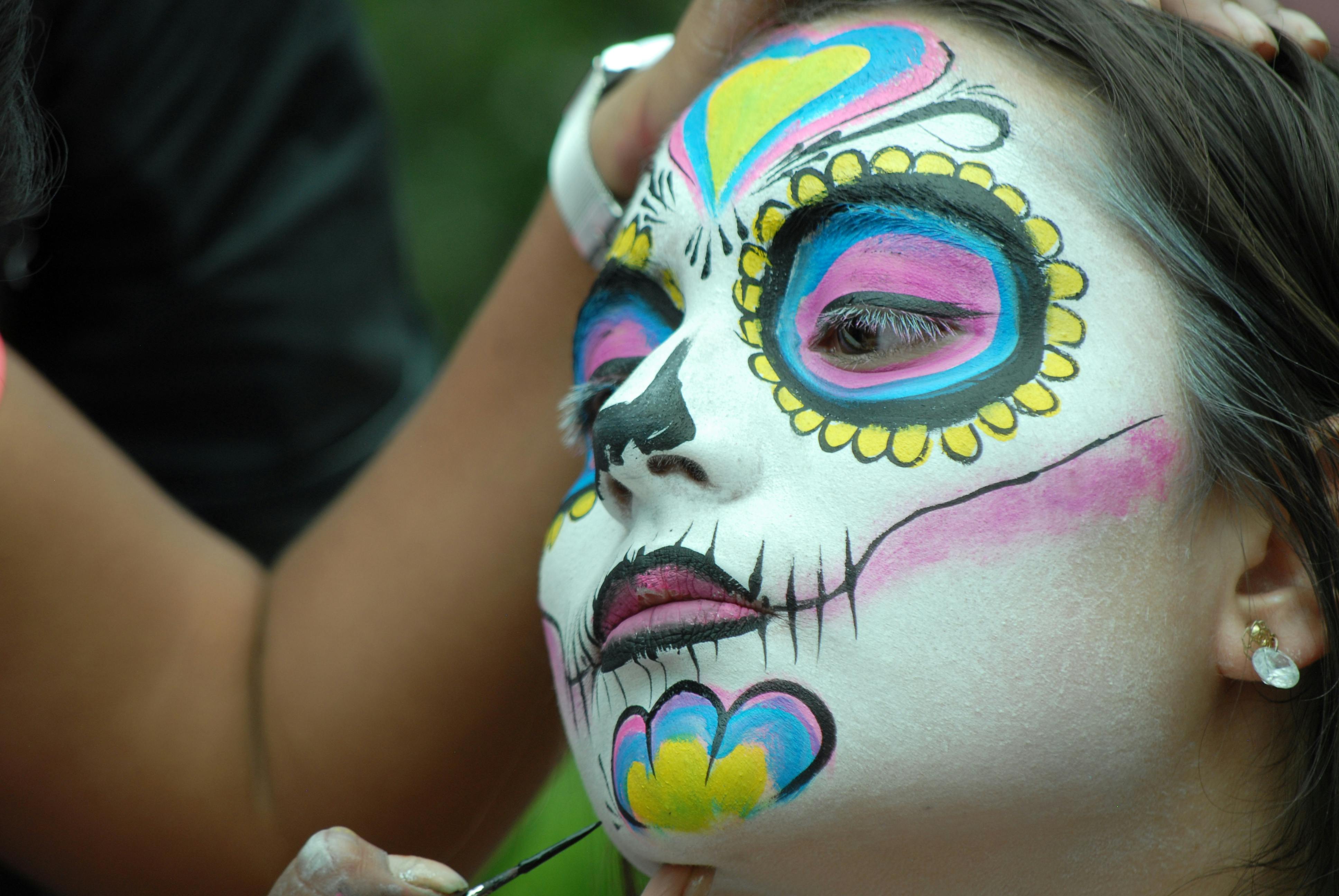 A Close-Up Shot of a Woman Having Her Face Painted · Free Stock Photo