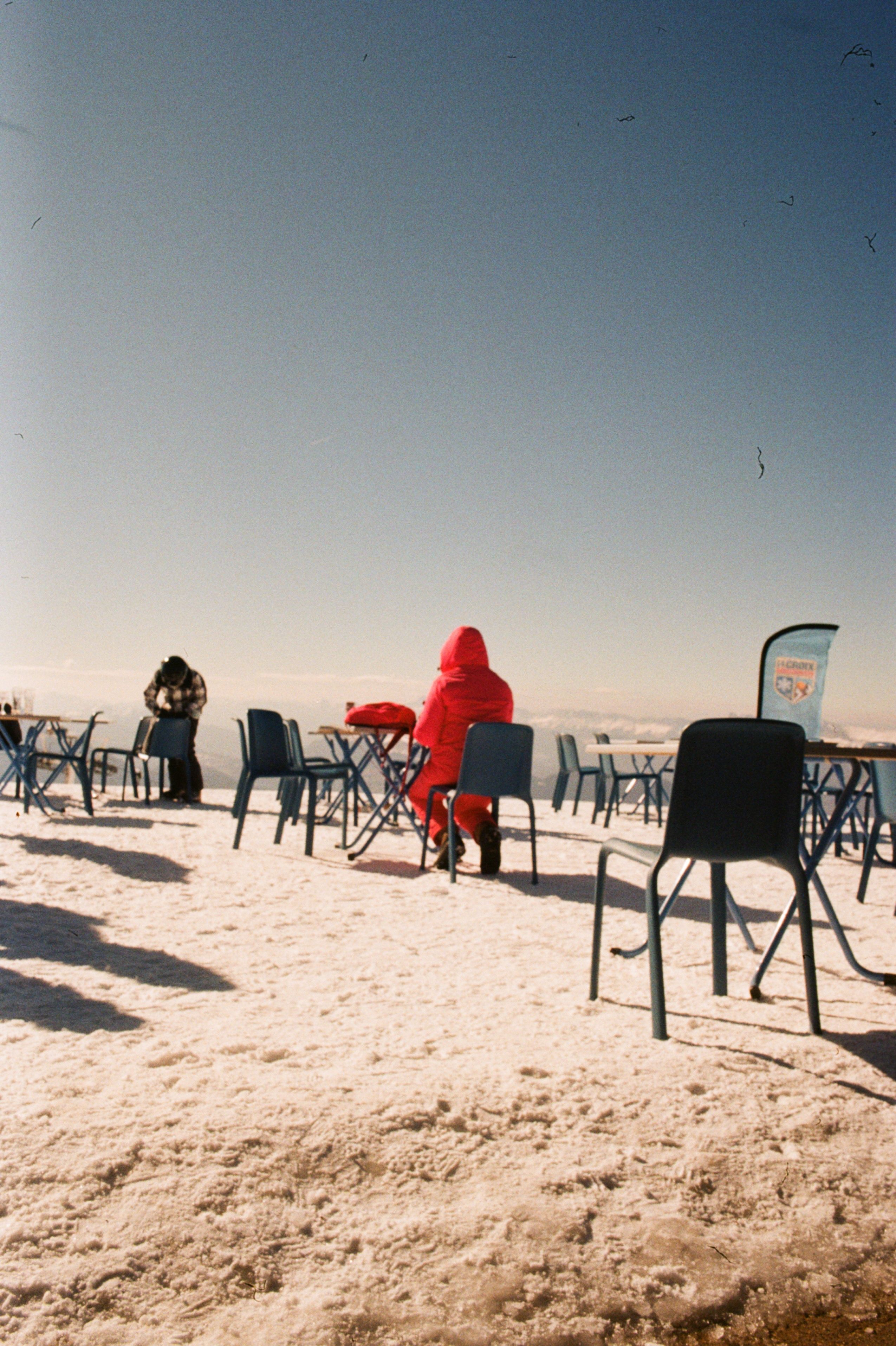 Man in Red Suit Sitting by Restaurant Table on Mountain Peak · Free ...