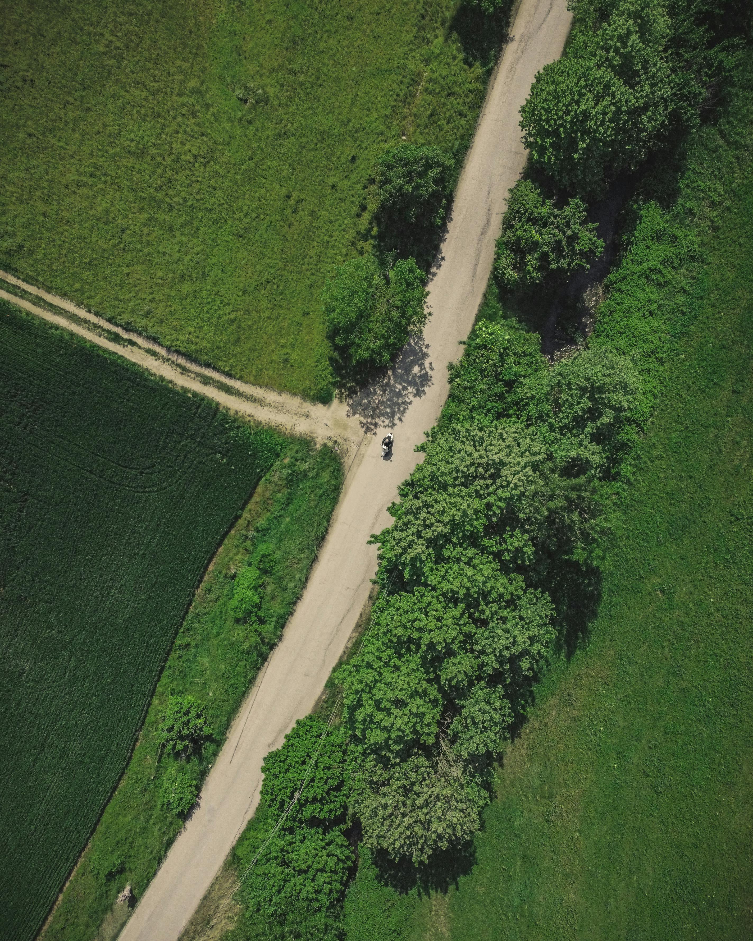 Aerial Shot of Roads Between Green Grass Field · Free Stock Photo