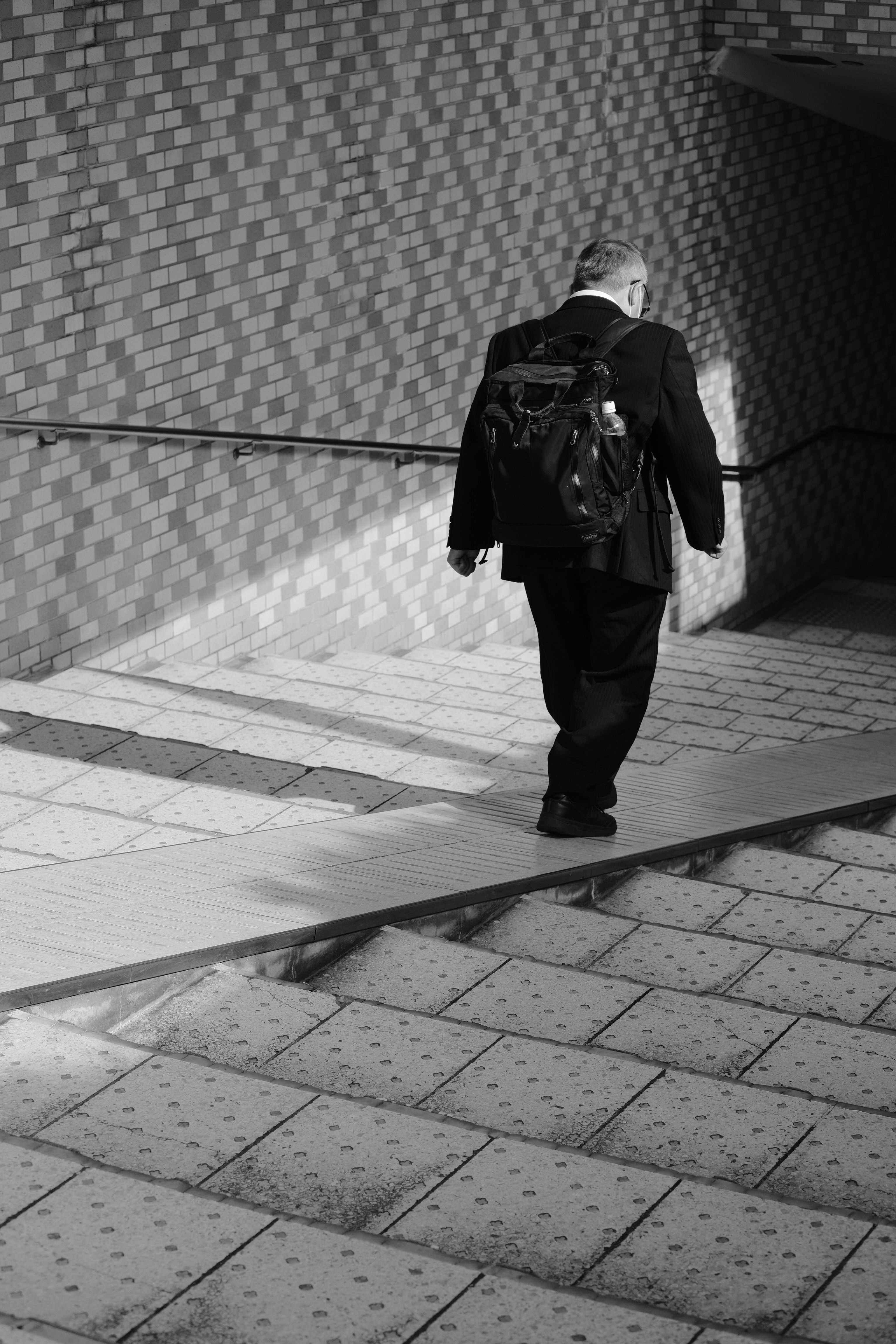 Man Walking Downstairs in Black and White · Free Stock Photo