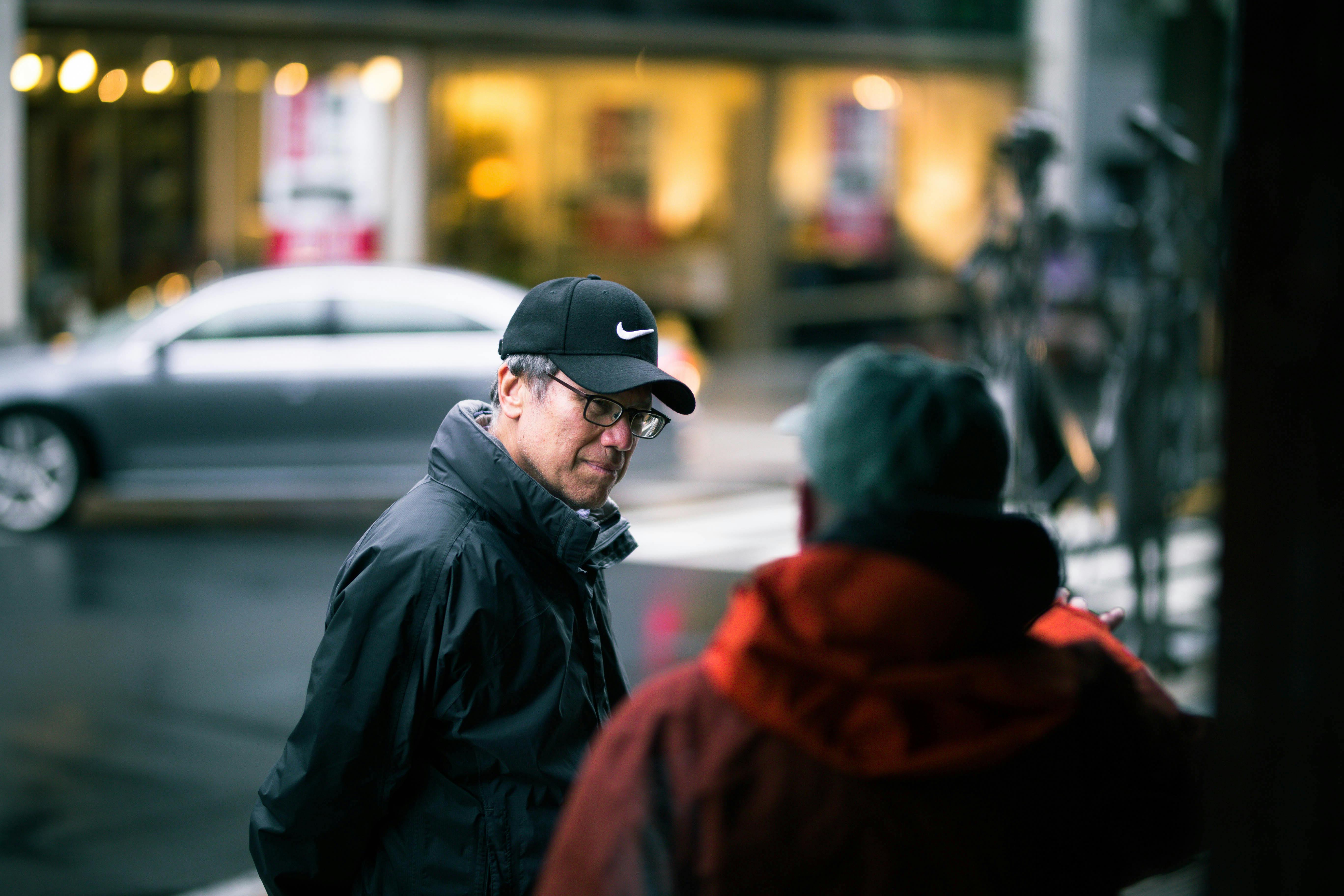 A Man Wearing a Cap while Looking Down · Free Stock Photo