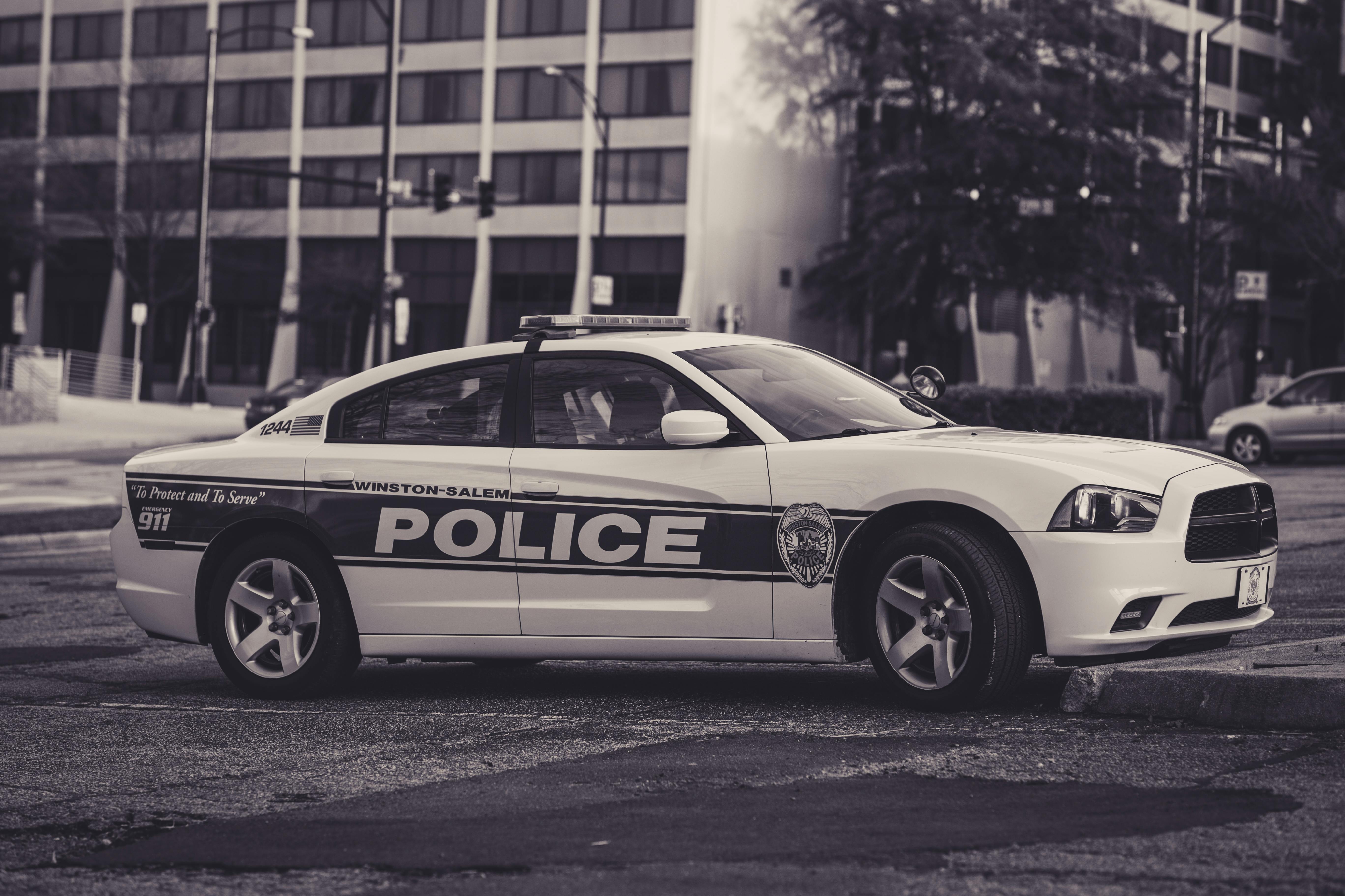 Police Car Parked Near Building · Free Stock Photo