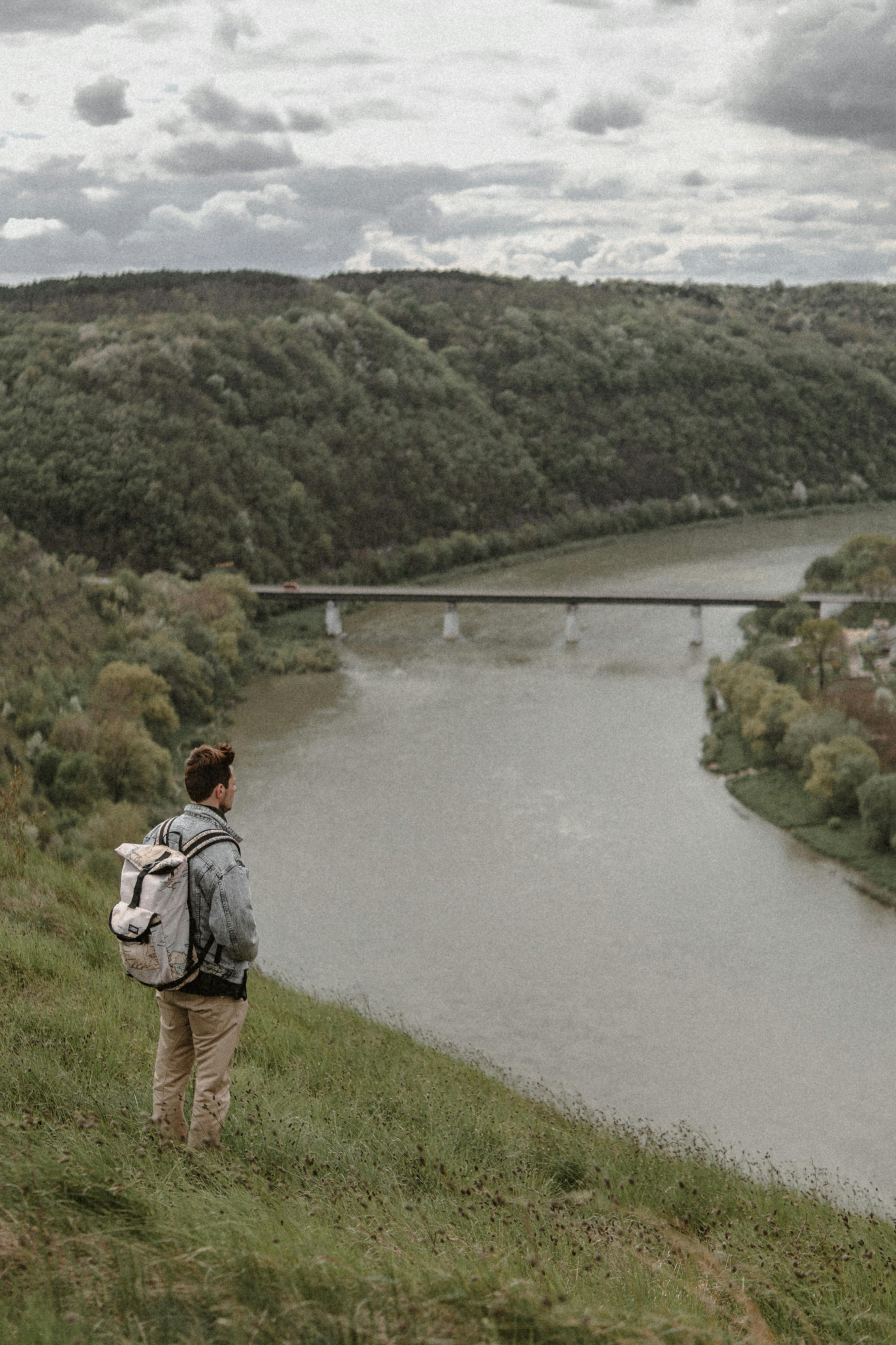 Man Looking at Bridge on River · Free Stock Photo