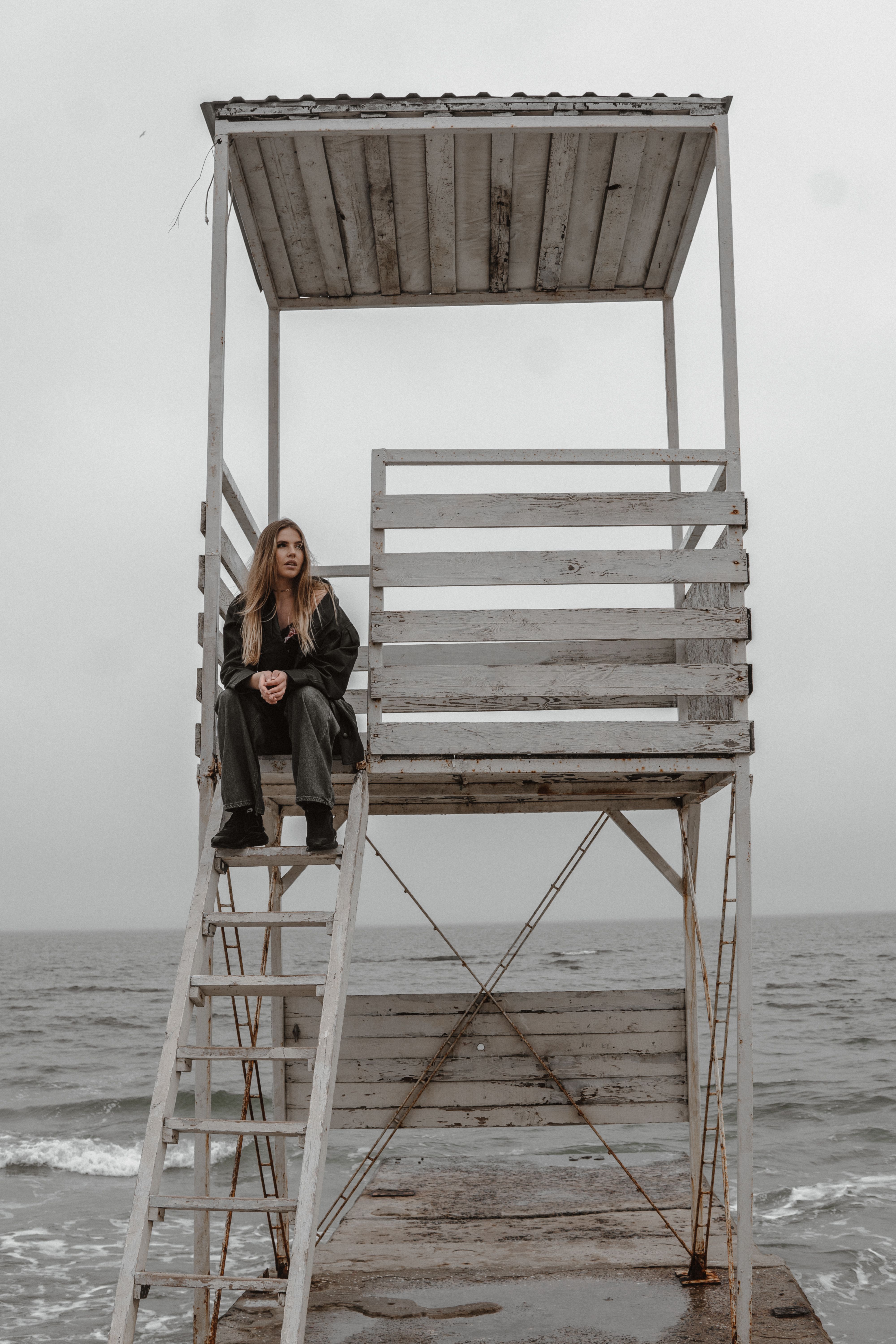 Woman Sitting on Lifeguard Tower on Beach · Free Stock Photo