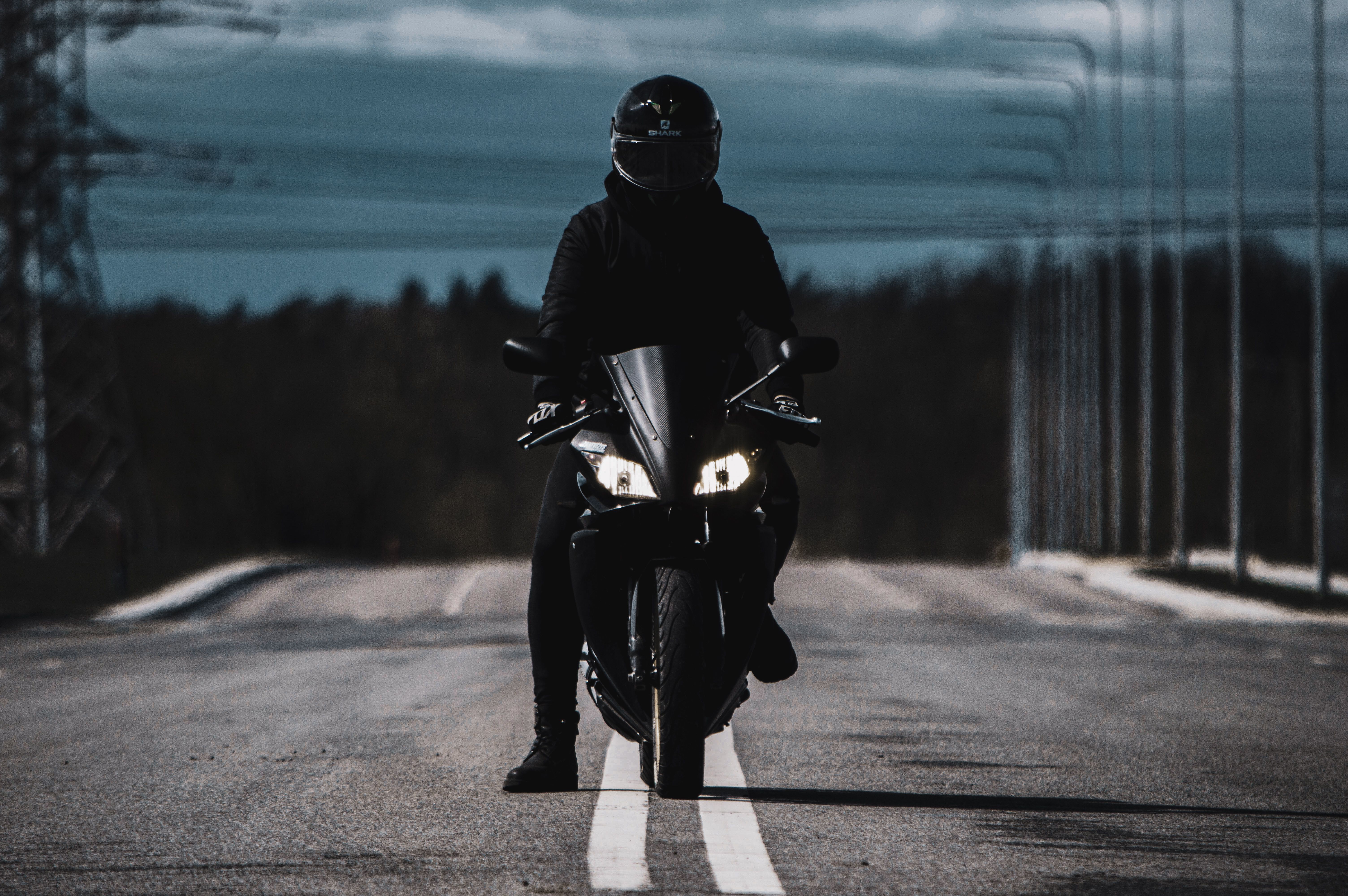 Person in Black Outfit Riding a Motorcycle on Road · Free Stock Photo