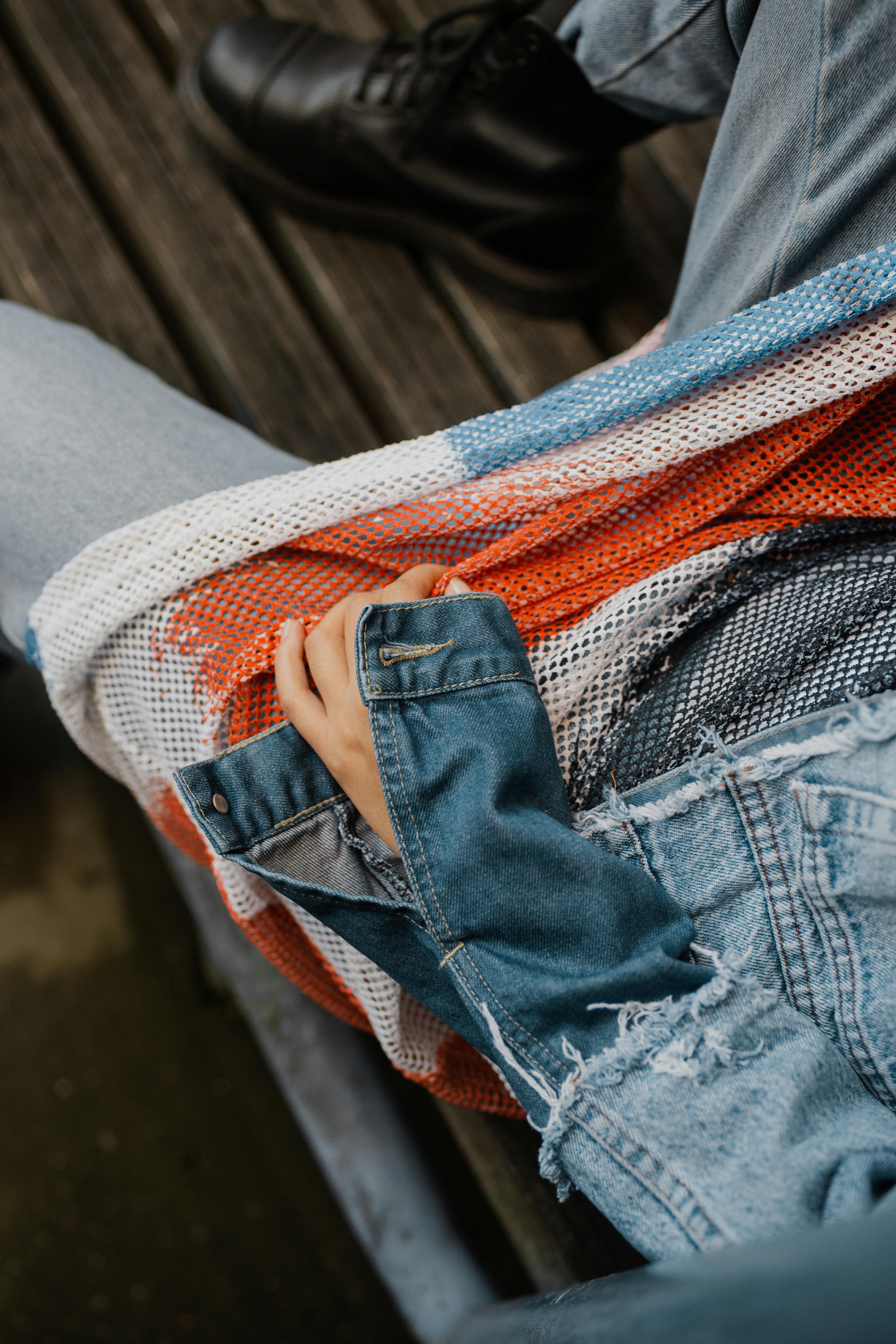 Person in Denim Clothes Sitting on a Bench · Free Stock Photo