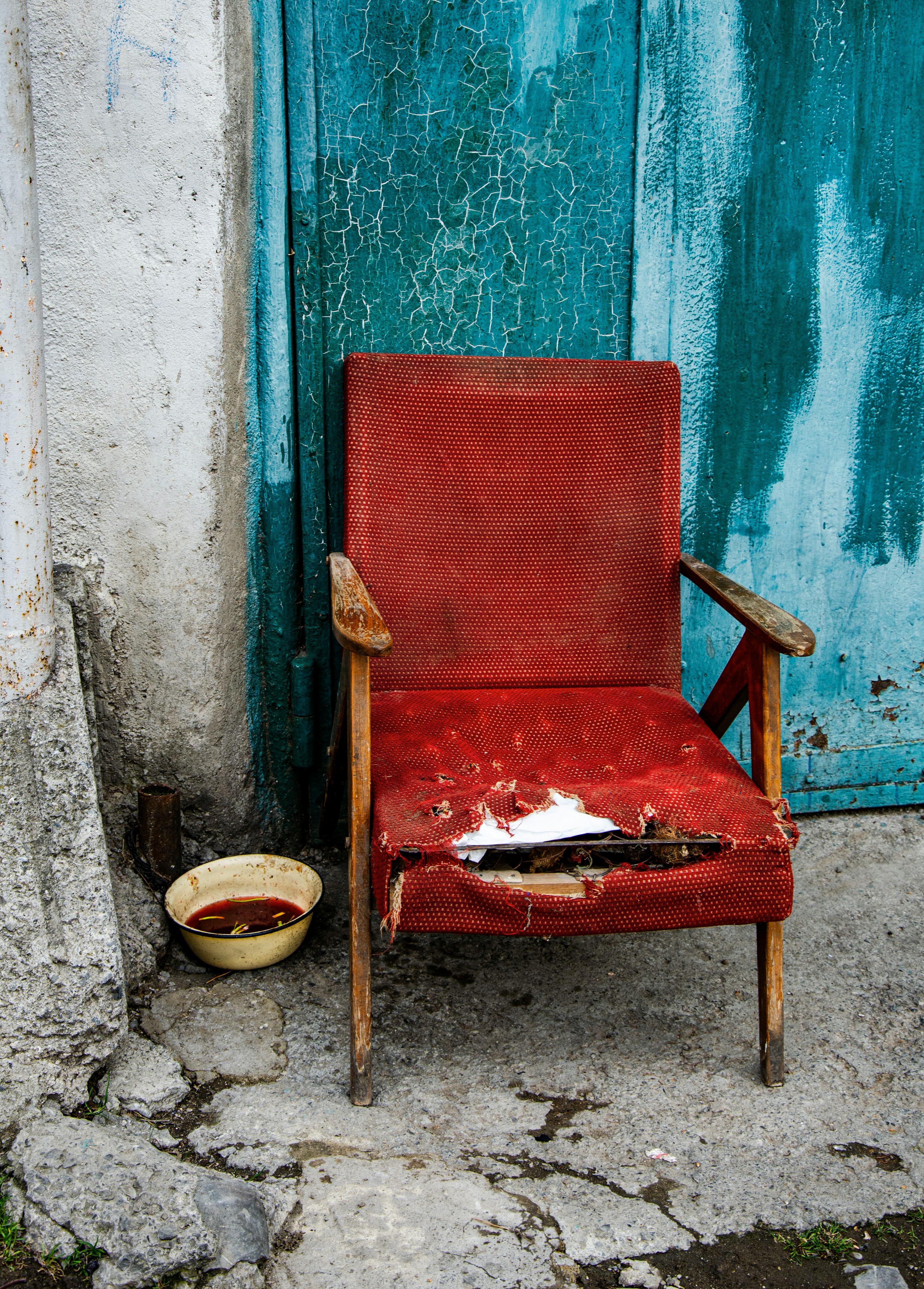 A Broken Red Chair on a Concrete · Free Stock Photo