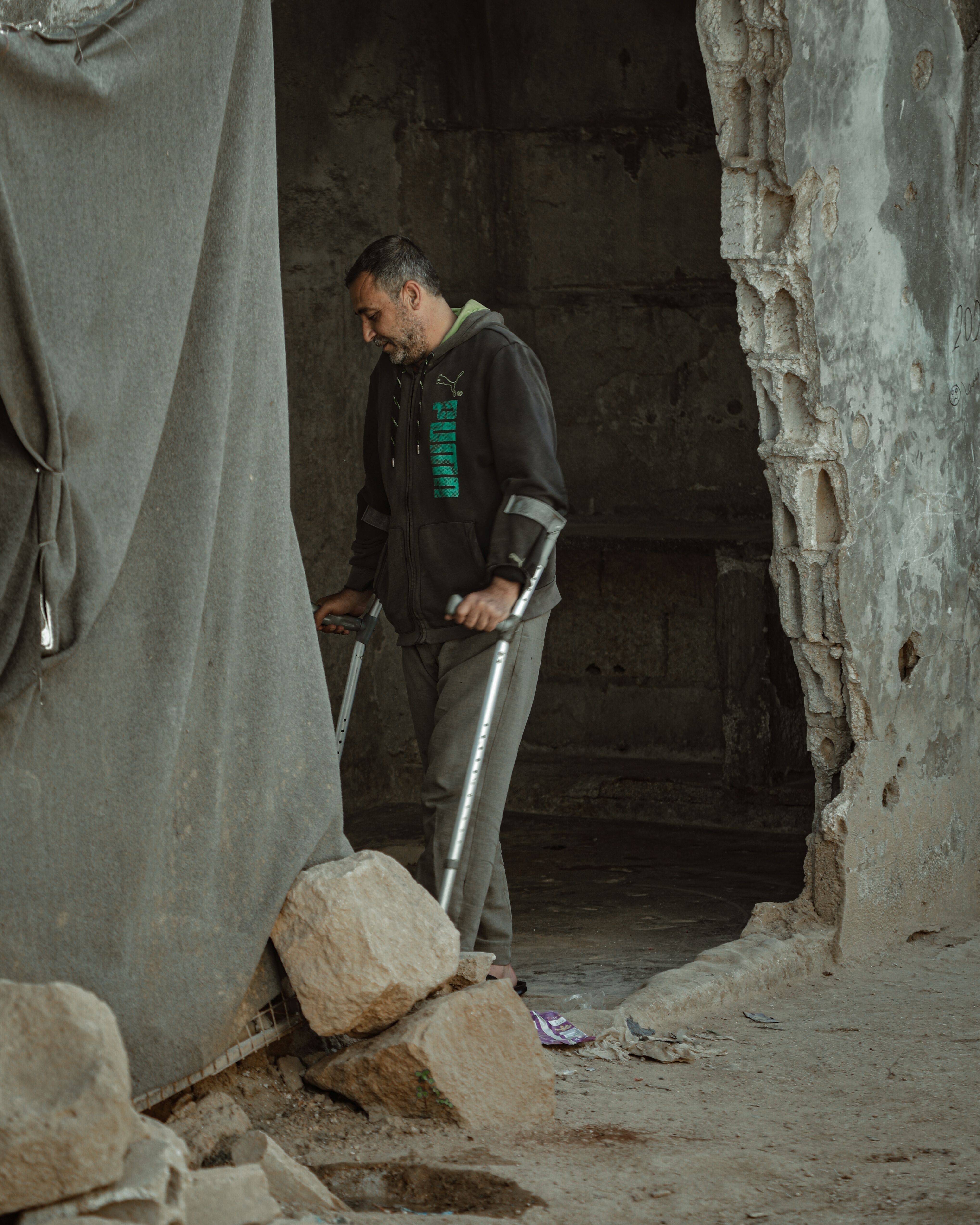 Man with Crouches Walking on a Rubble · Free Stock Photo