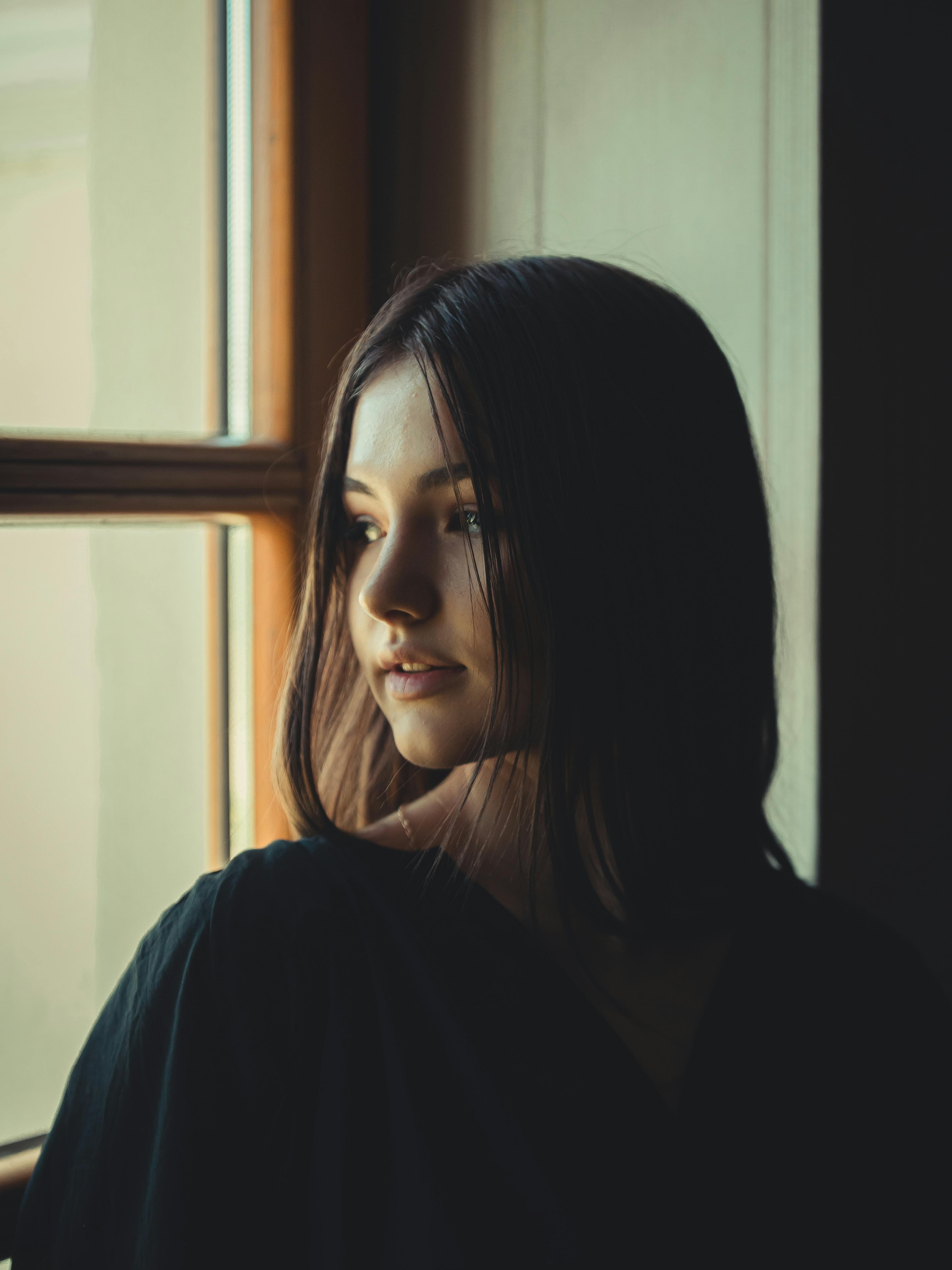 A Woman Looking Outside the Window · Free Stock Photo