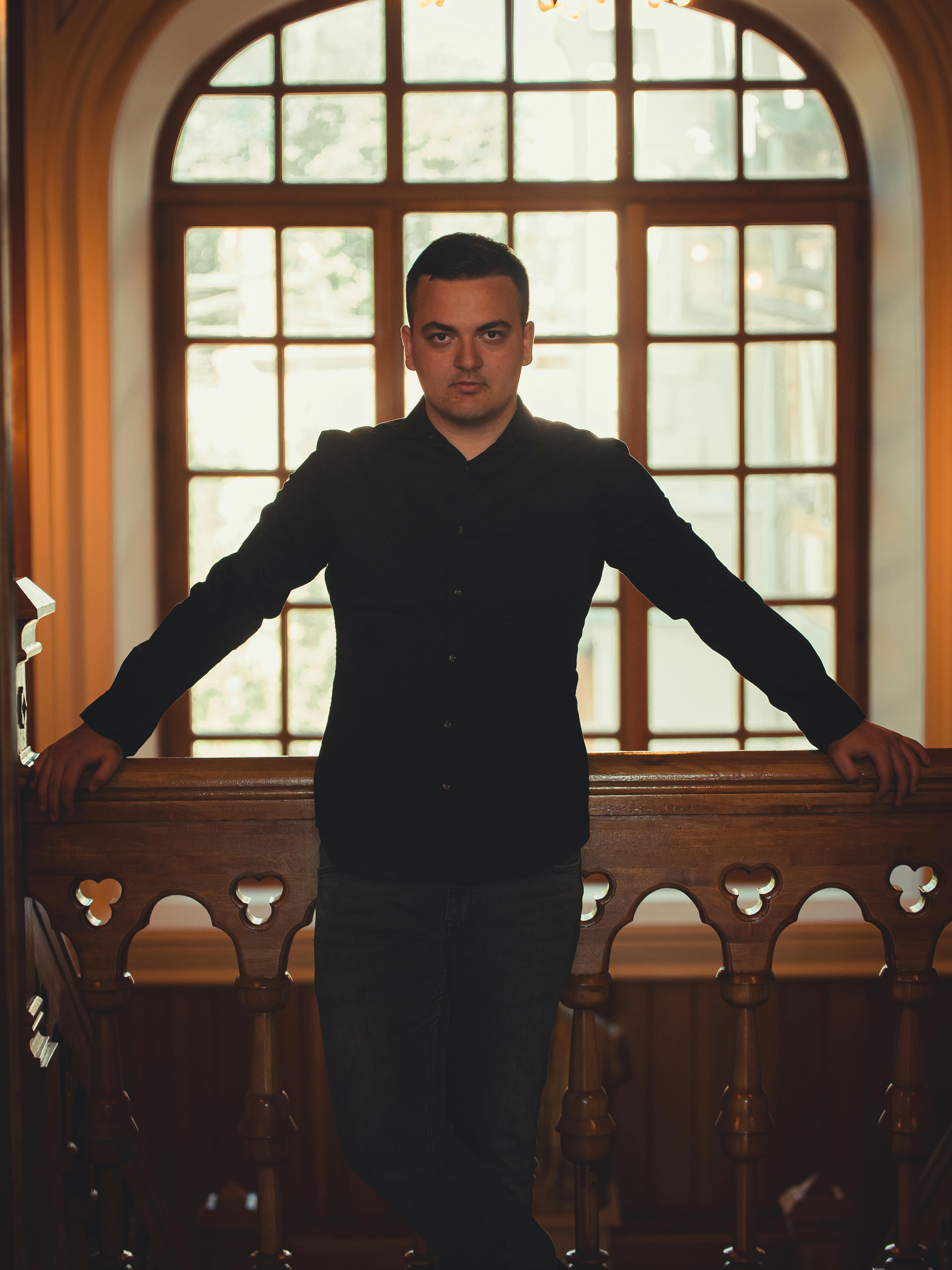 Man Posing by a Railing · Free Stock Photo