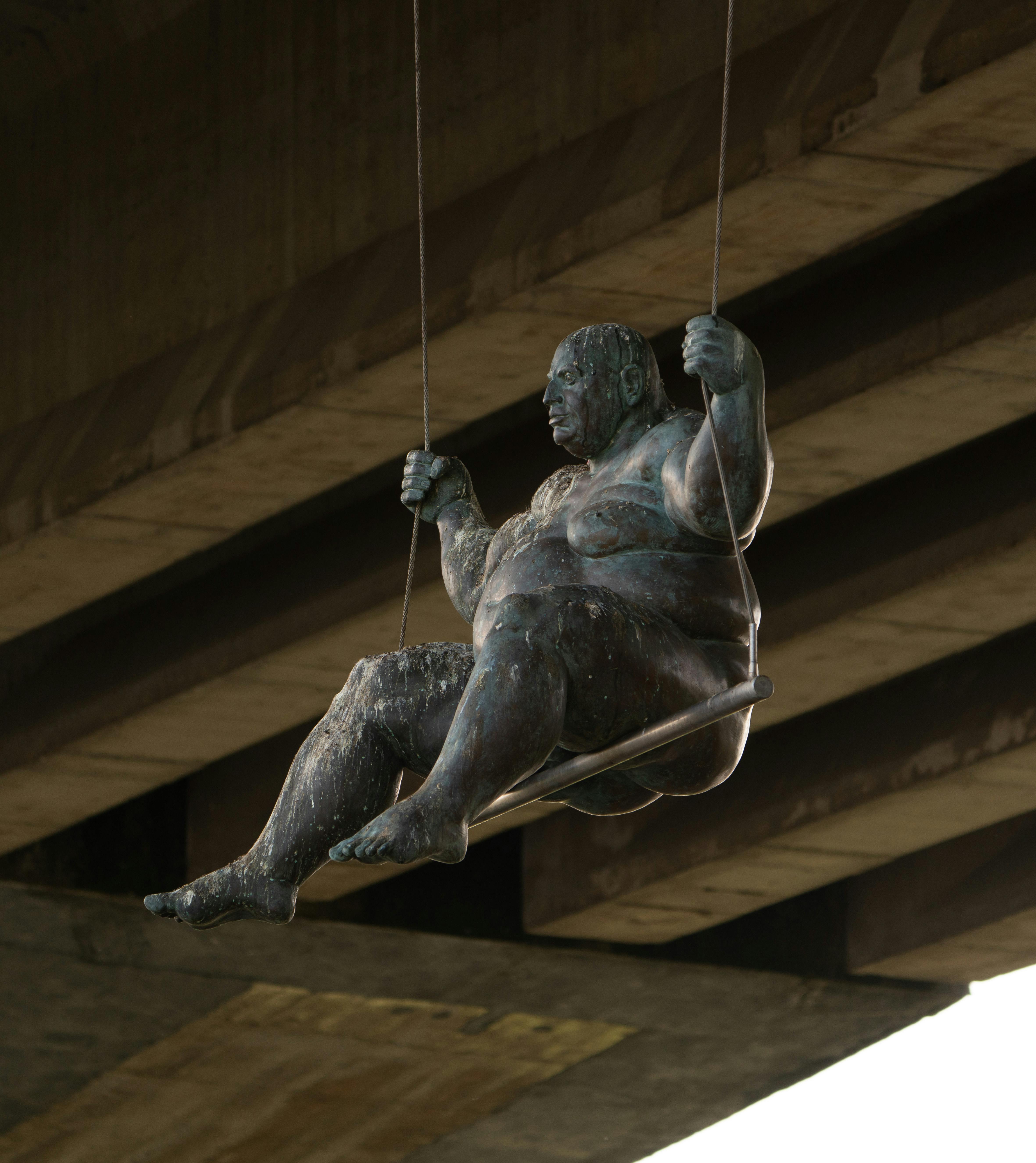Stone Statue on Swing Hanging from Bridges Underside · Free Stock Photo