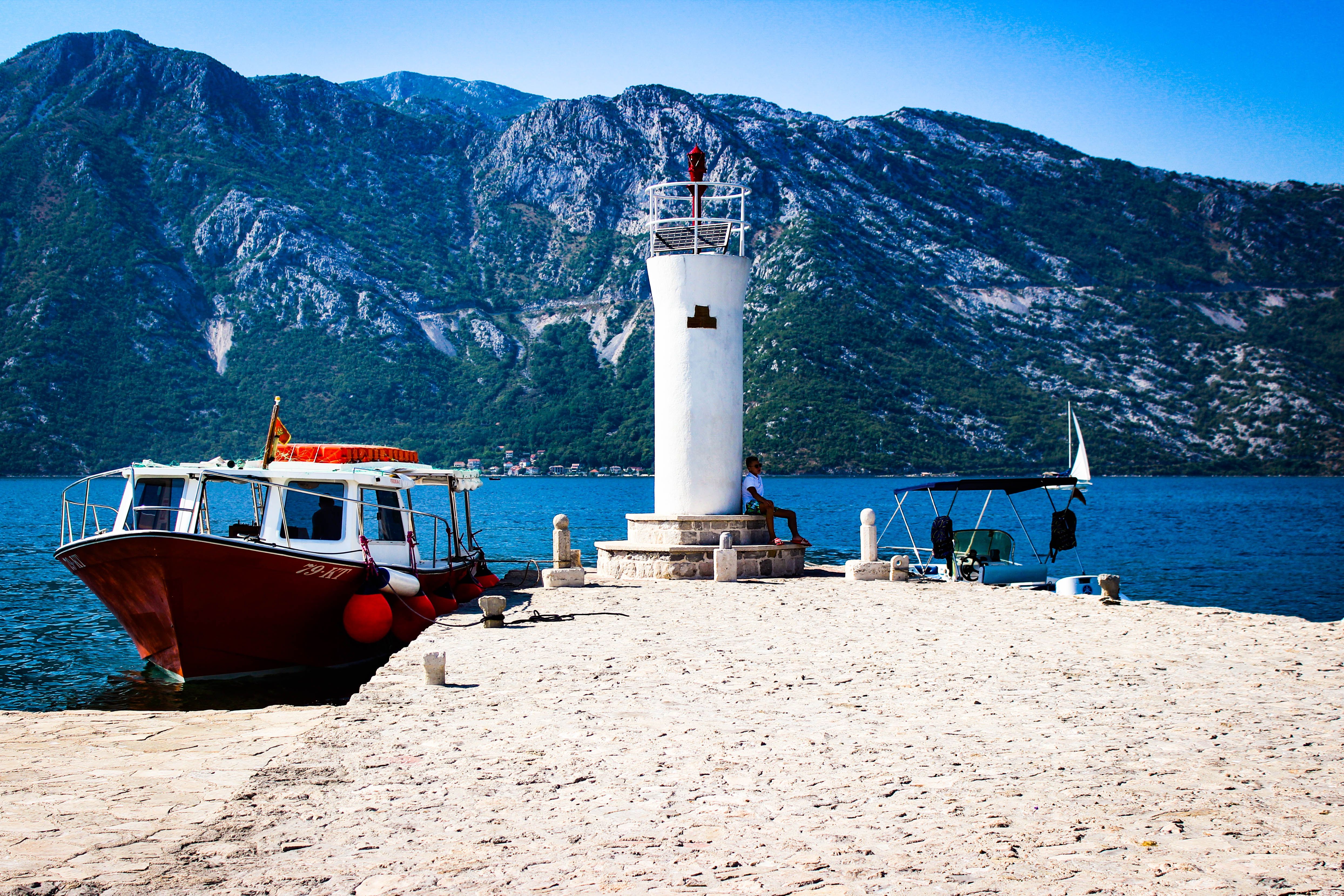 Seascape with Boat and Small Lighthouse · Free Stock Photo
