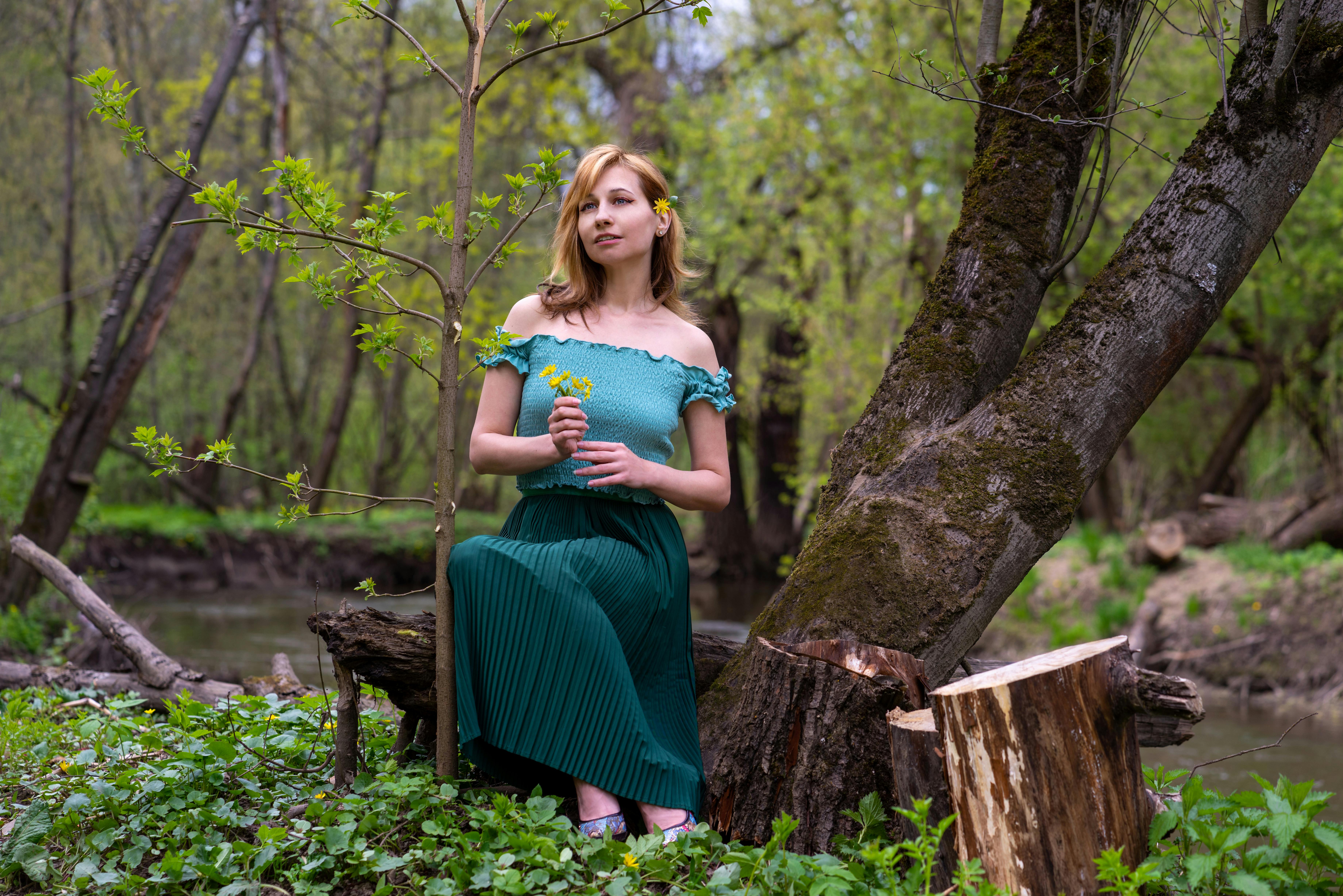 Blonde Woman Wearing Beige Coat Leaning on Tree Trunk · Free Stock Photo