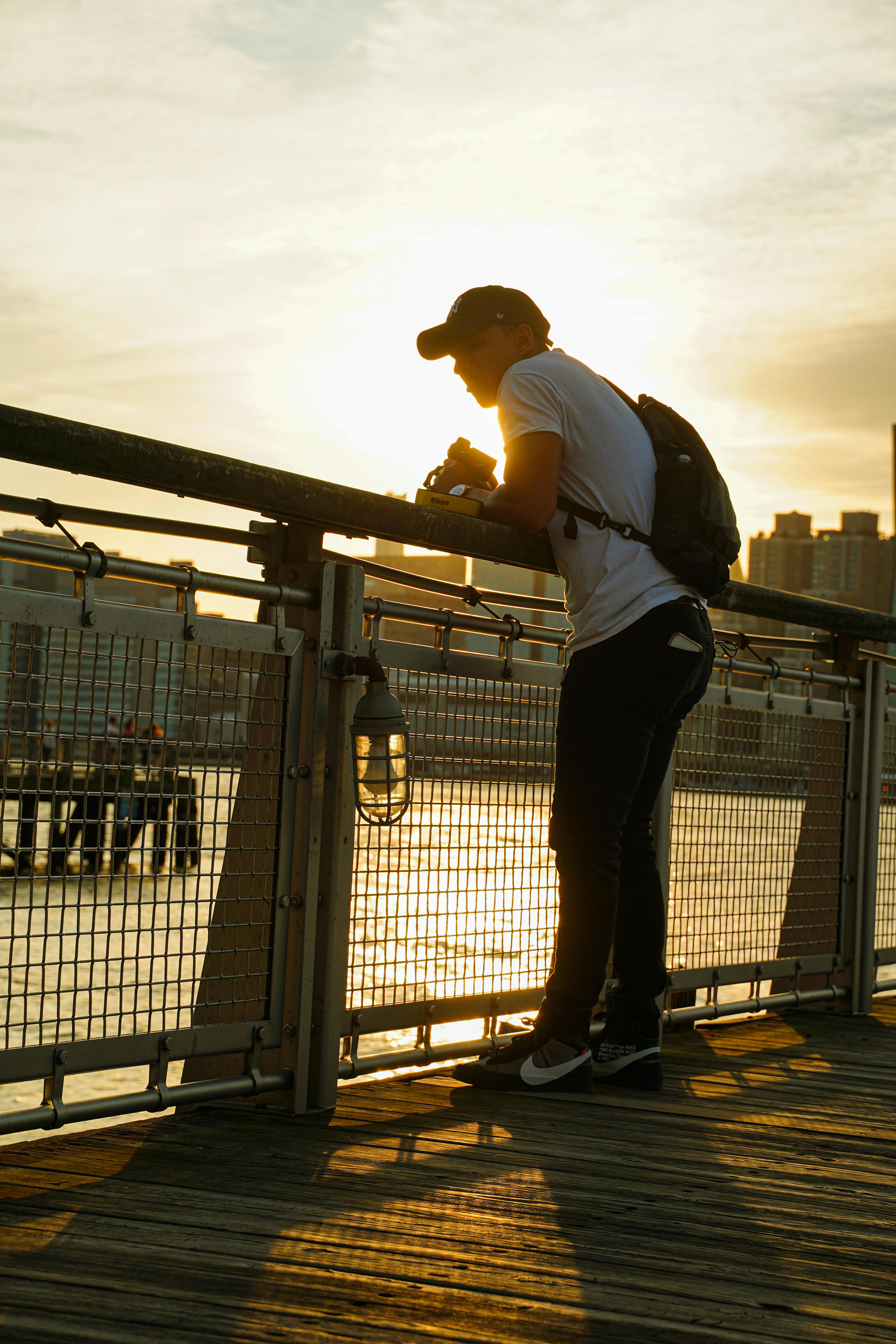 Man leaning on Handrail by the Riverside · Free Stock Photo