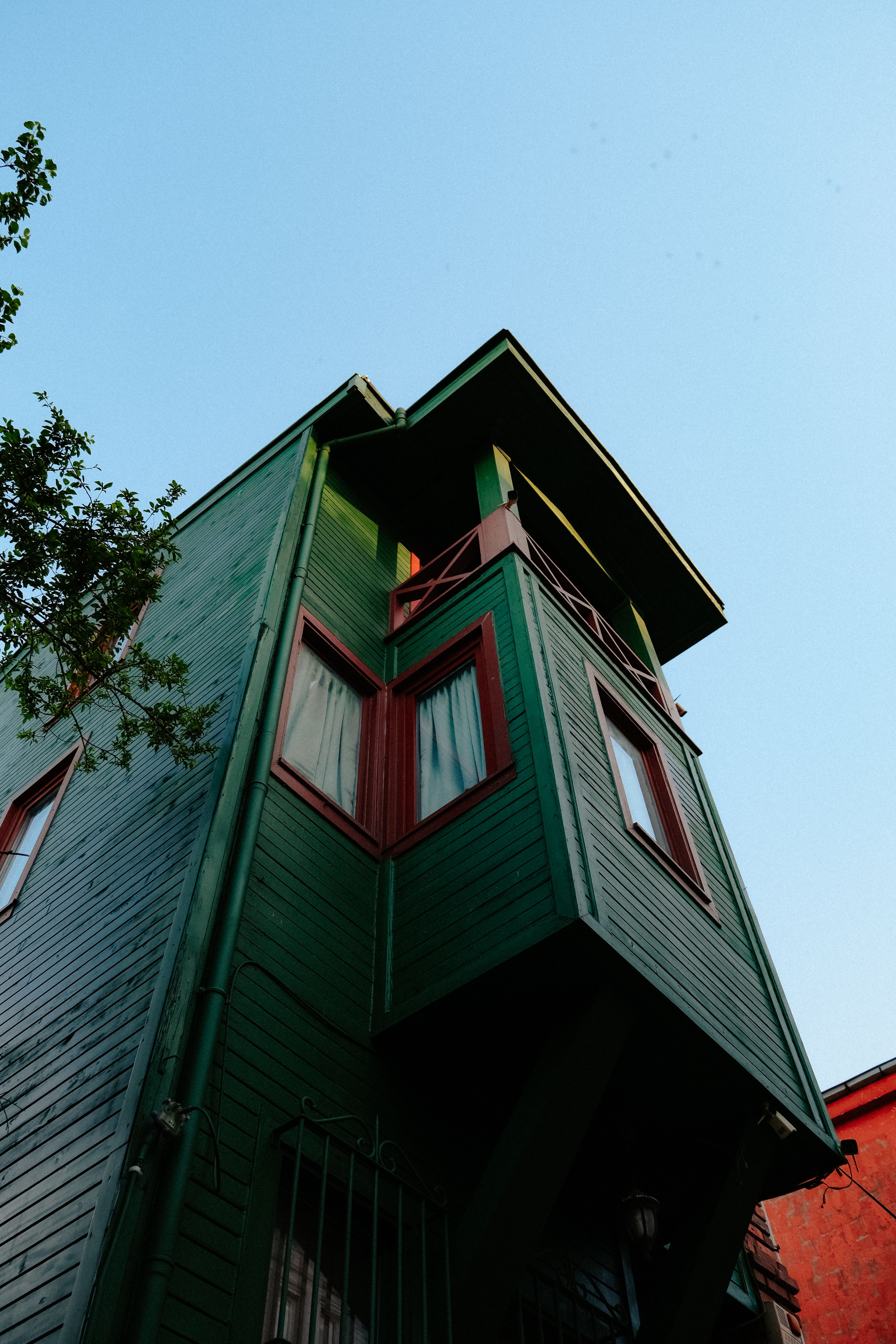 Low Angle Shot of a Green Wooden House · Free Stock Photo